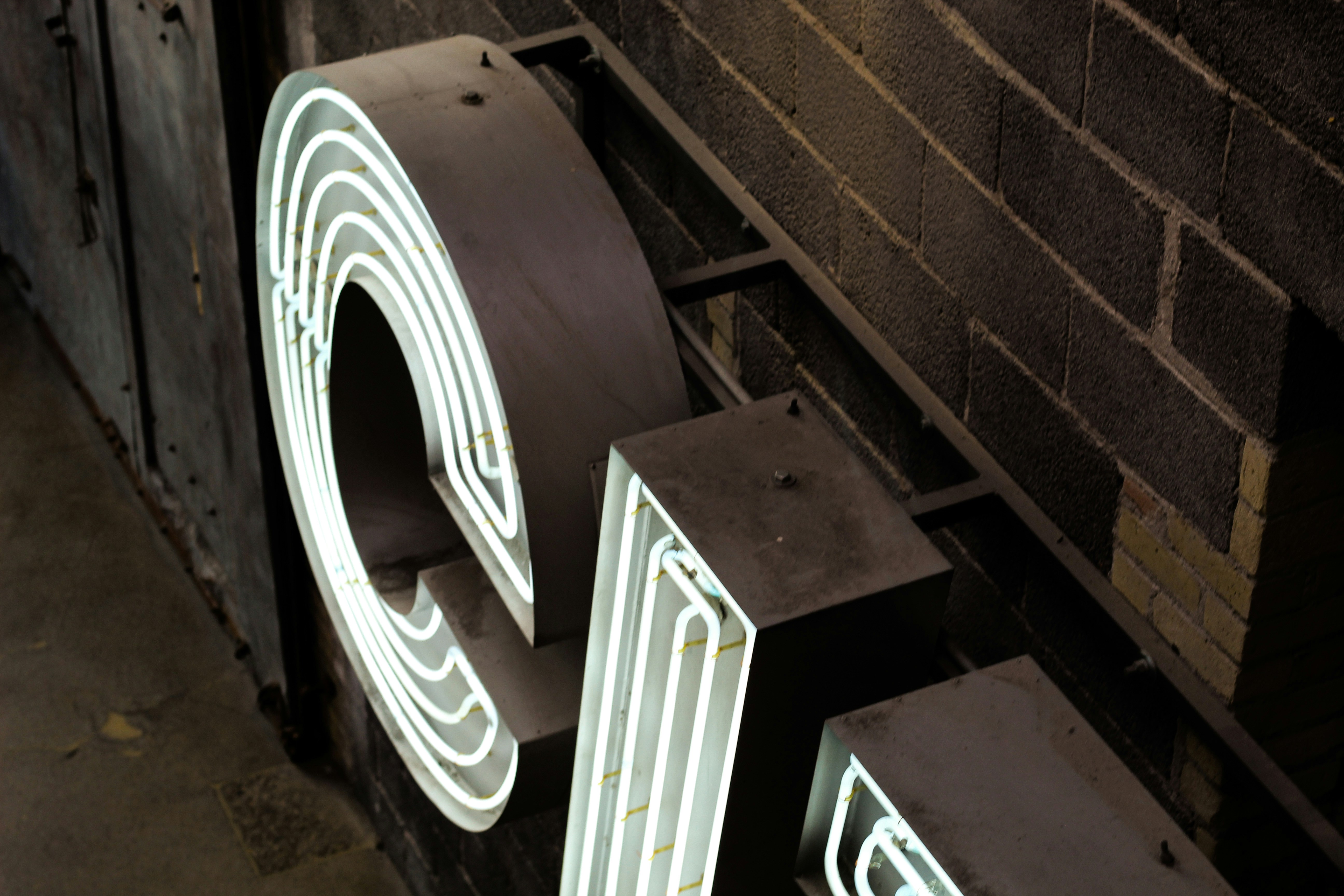 Neon Letters in a Flicker of Night