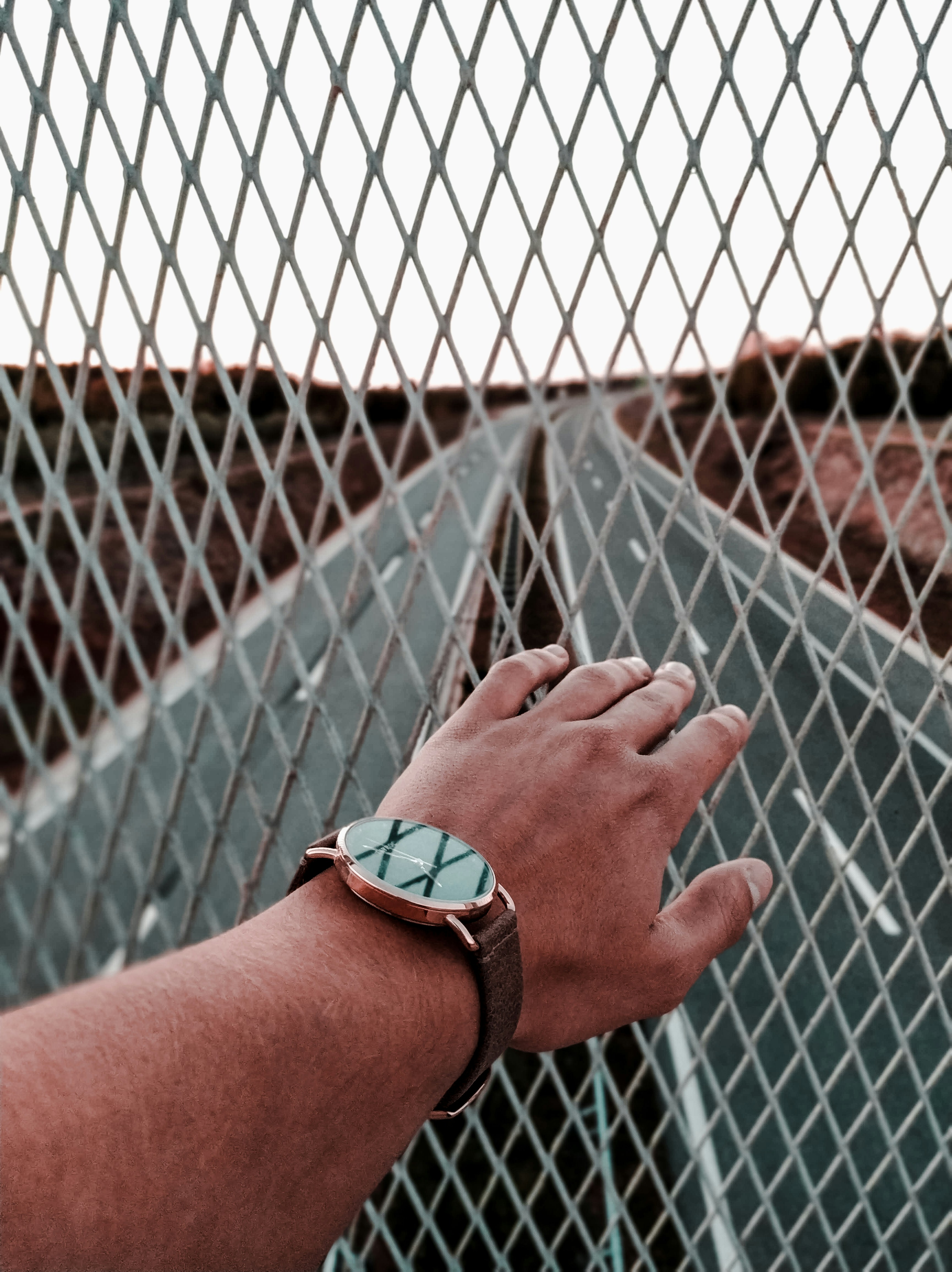 Time Grips the Mesh: Hand and Watch on a Converging Bridge Span