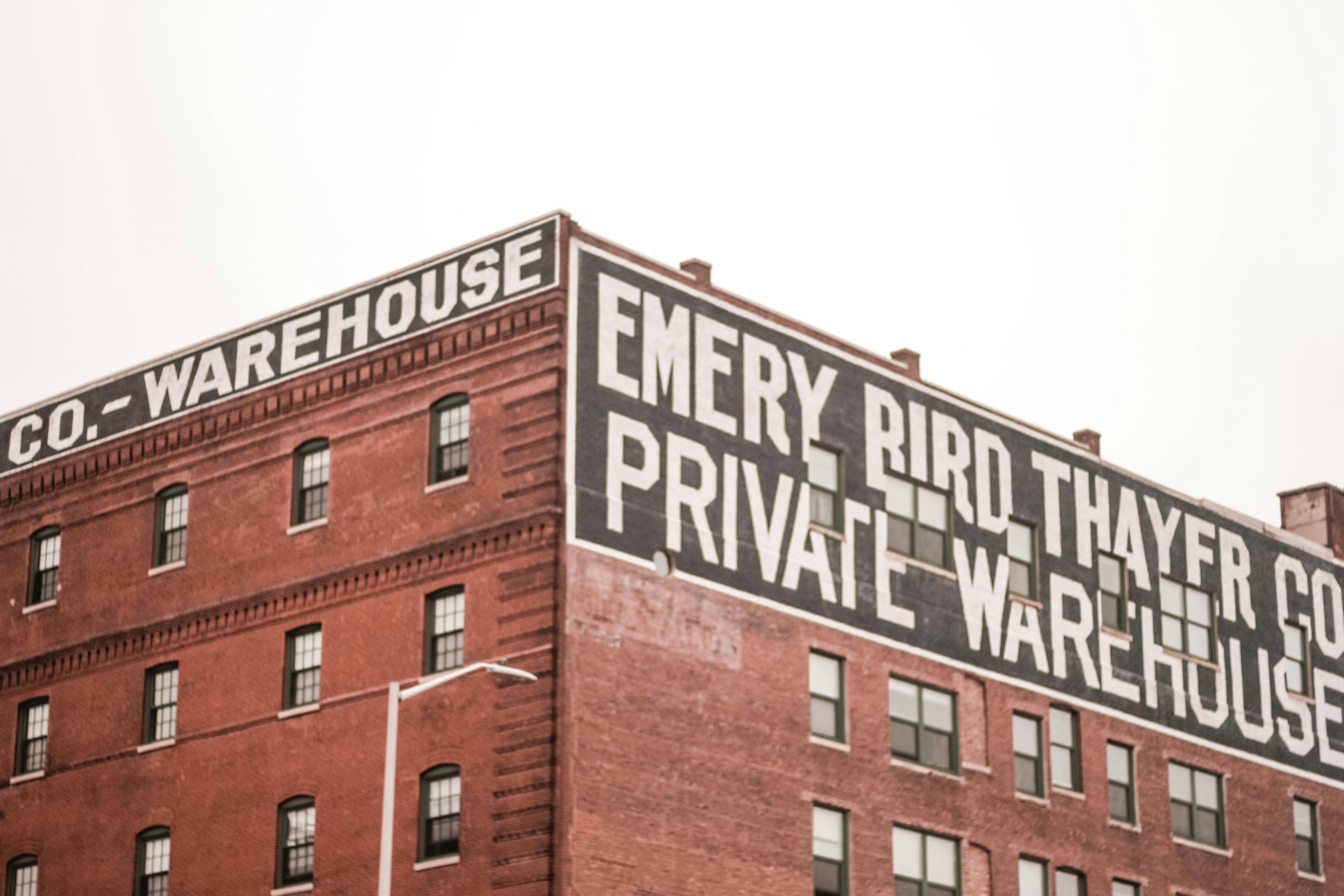 Brick Warehouse Silhouette with Historic Street Signage