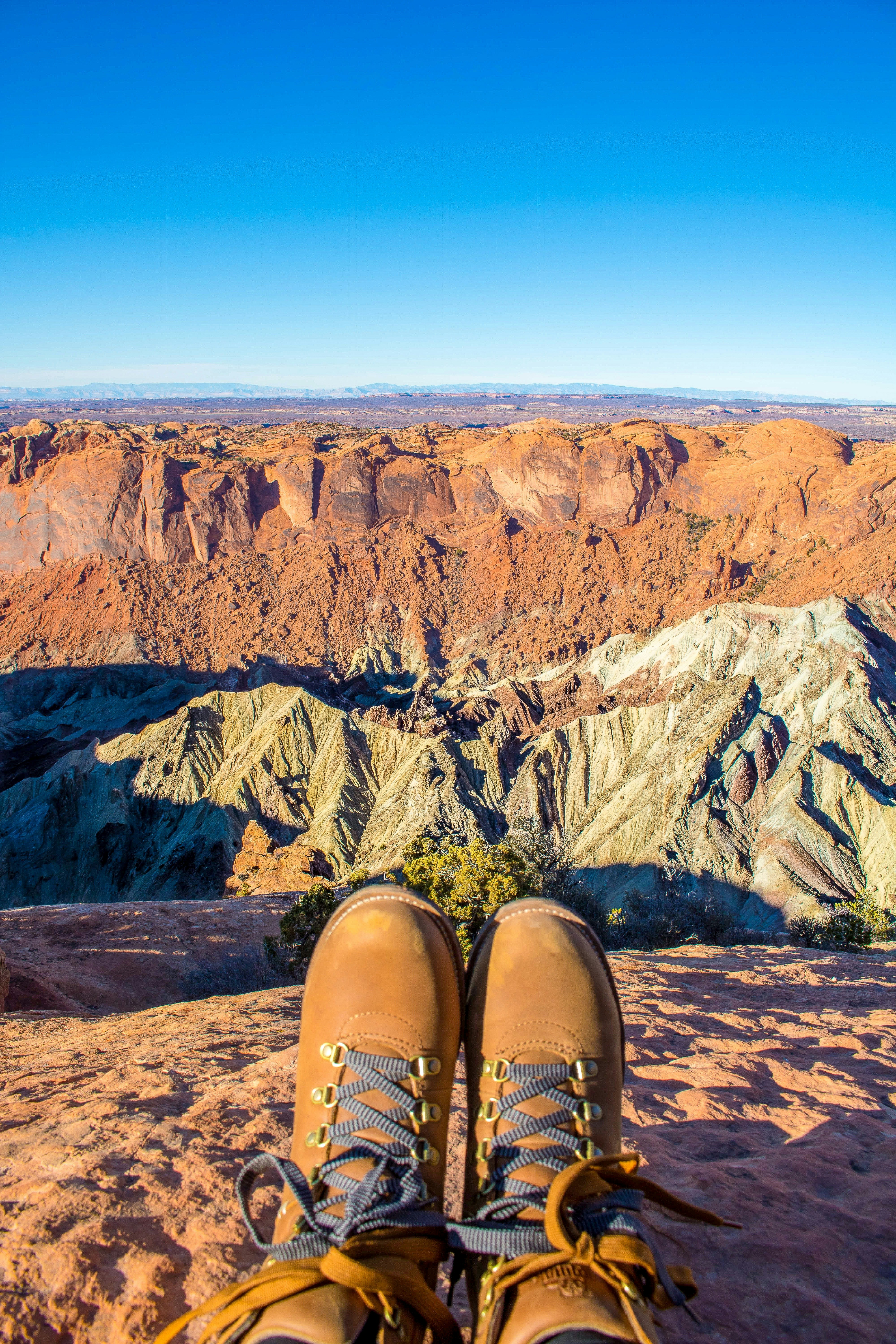 Boots on the Rim: a Quiet Pause Above a Layered Red Canyon