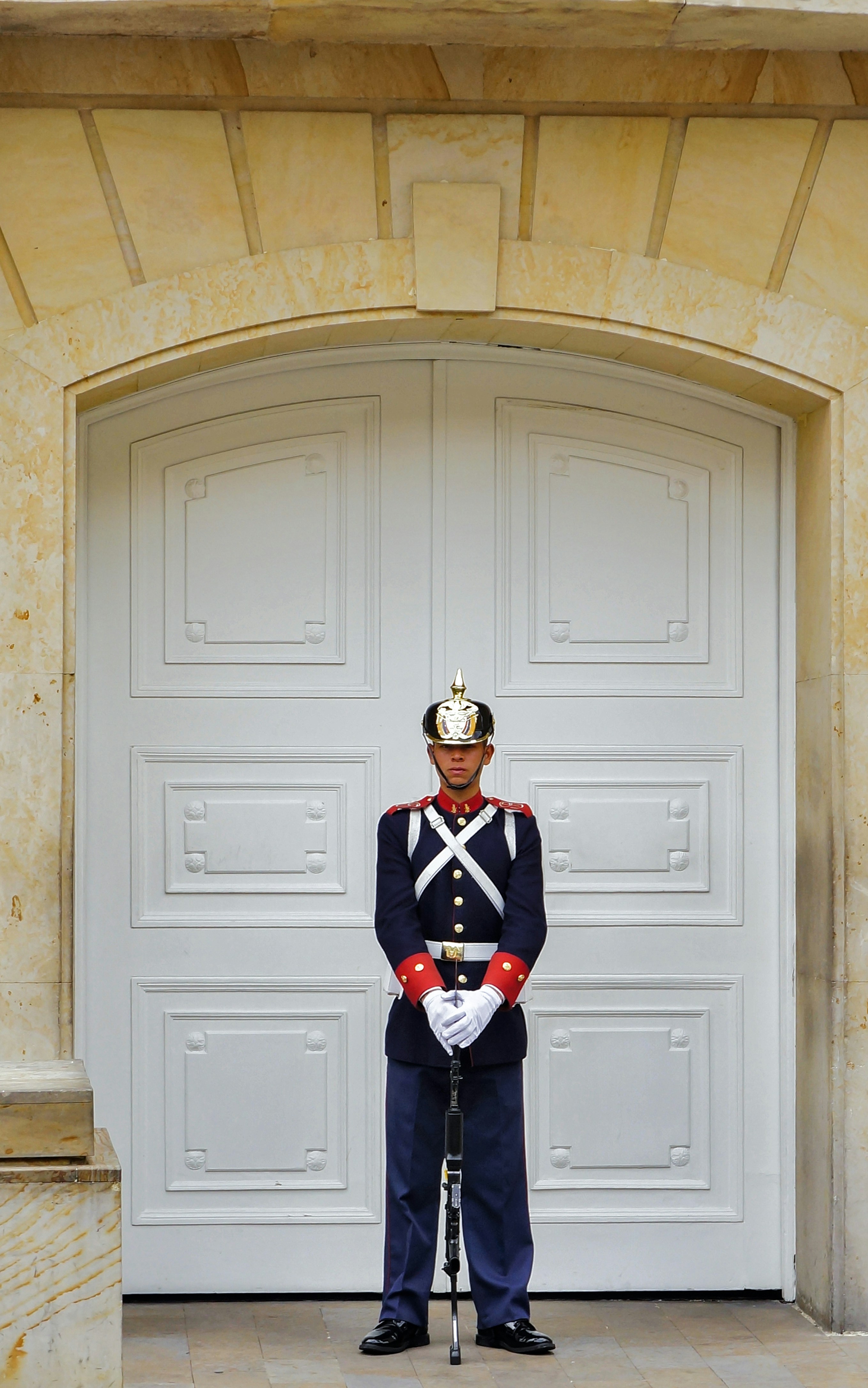 Gatekeeper Before a Marble Door