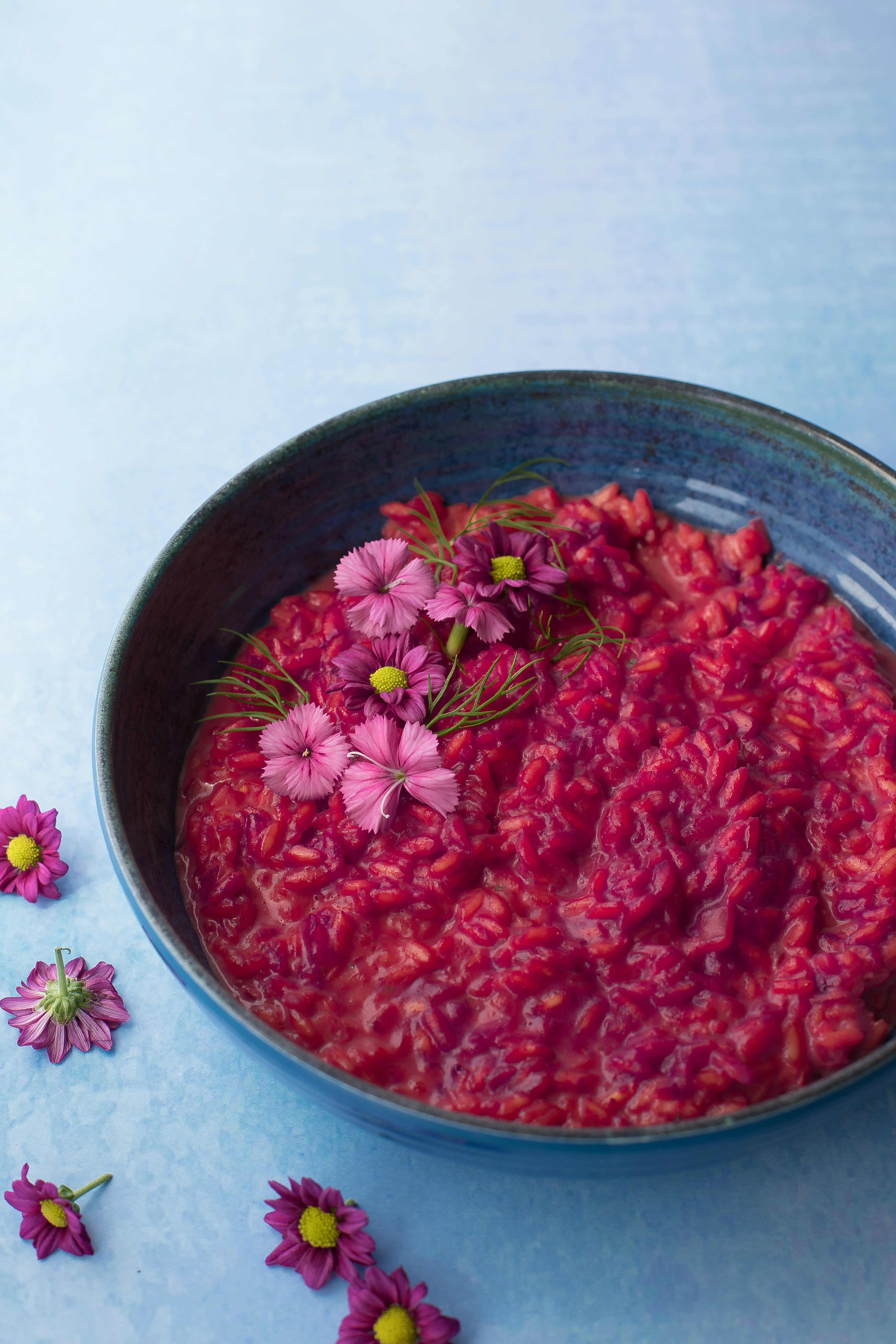 Pink Beet Purée in a Teal Bowl with Floral Garnish