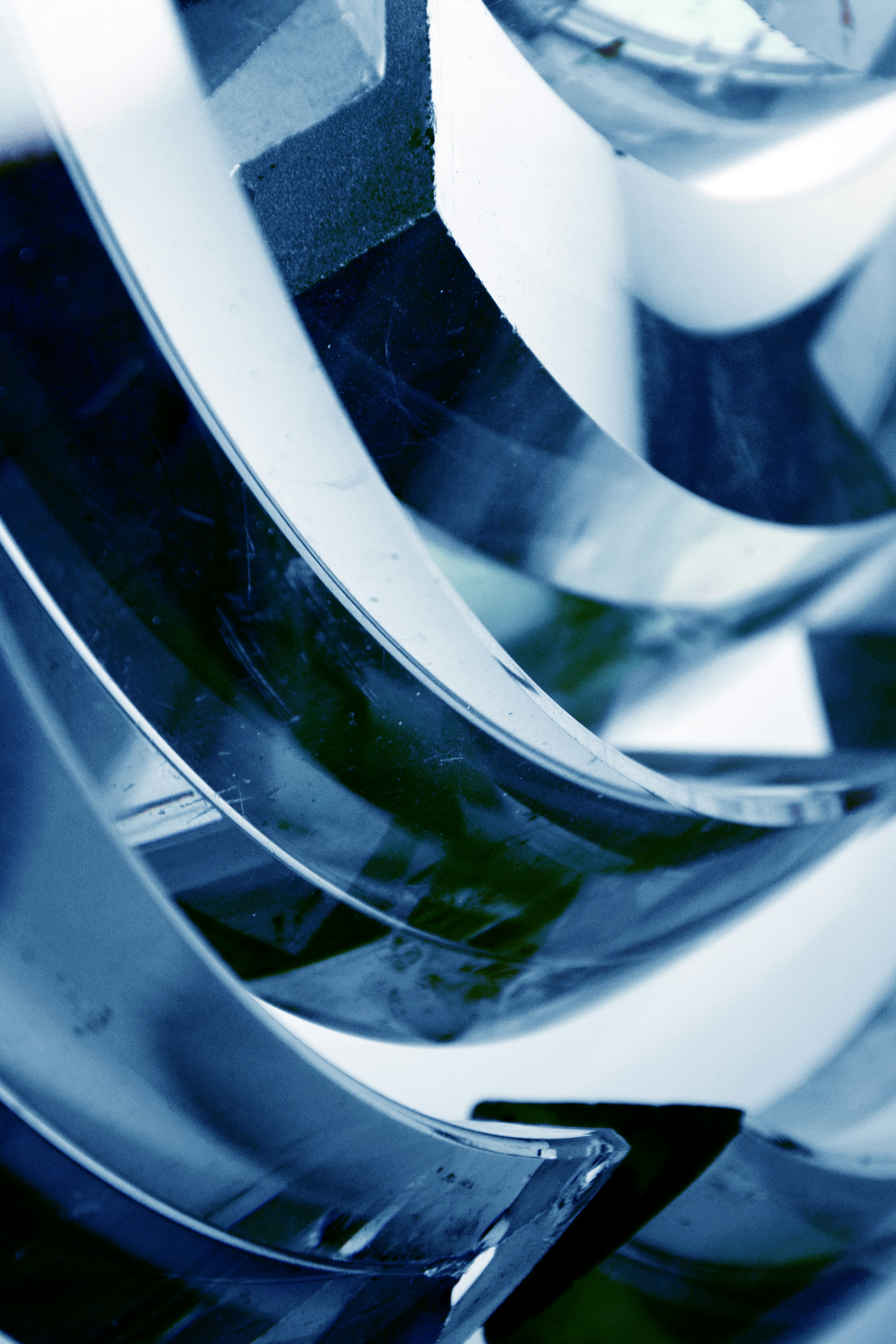 A close up of a metal object with a clock in the background photo ...