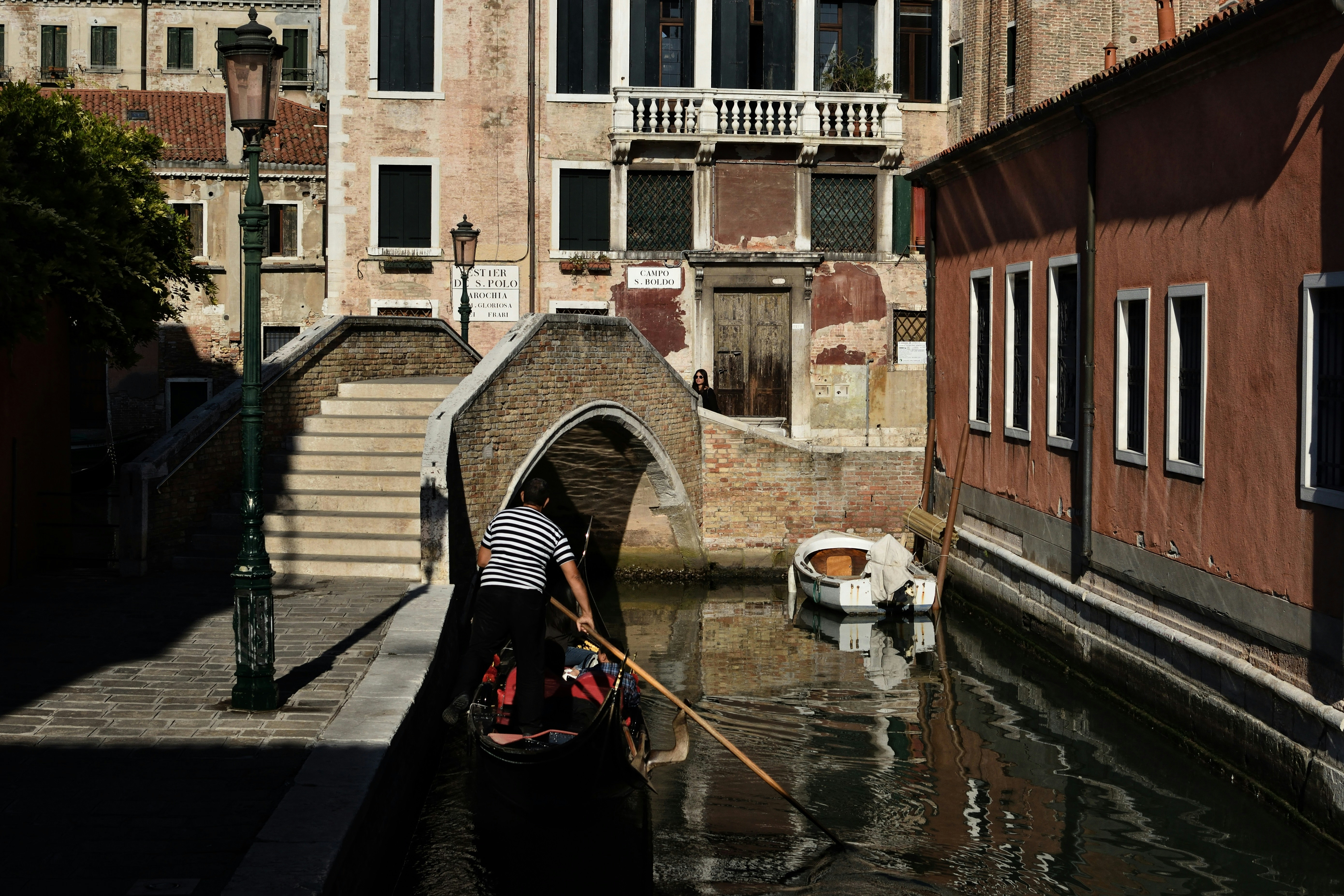 Gondola Drift Through a Venetian Canal Under a Narrow Bridge