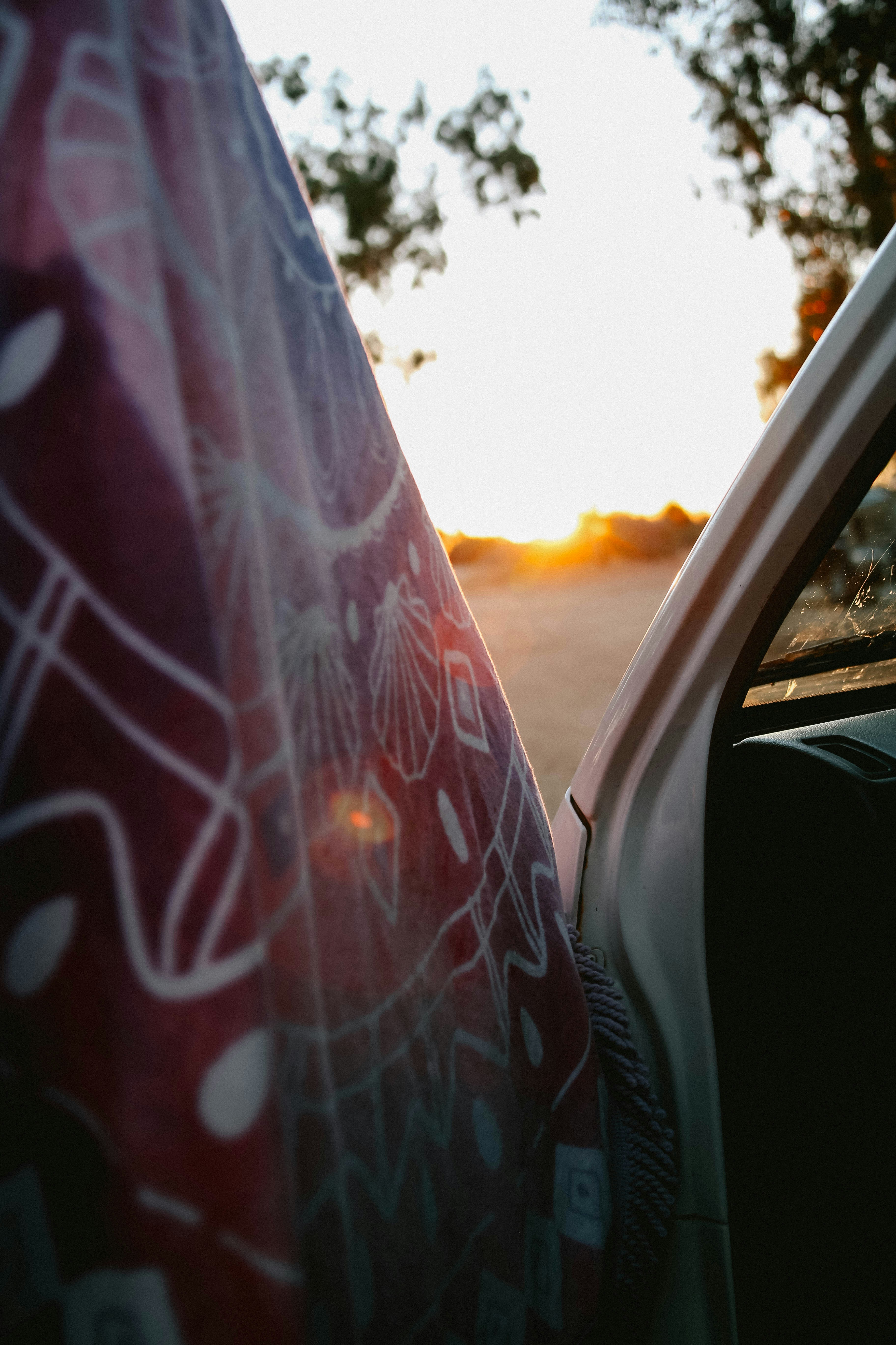 Horizon Filtered by Fabric: Sunset at the Car Door Threshold