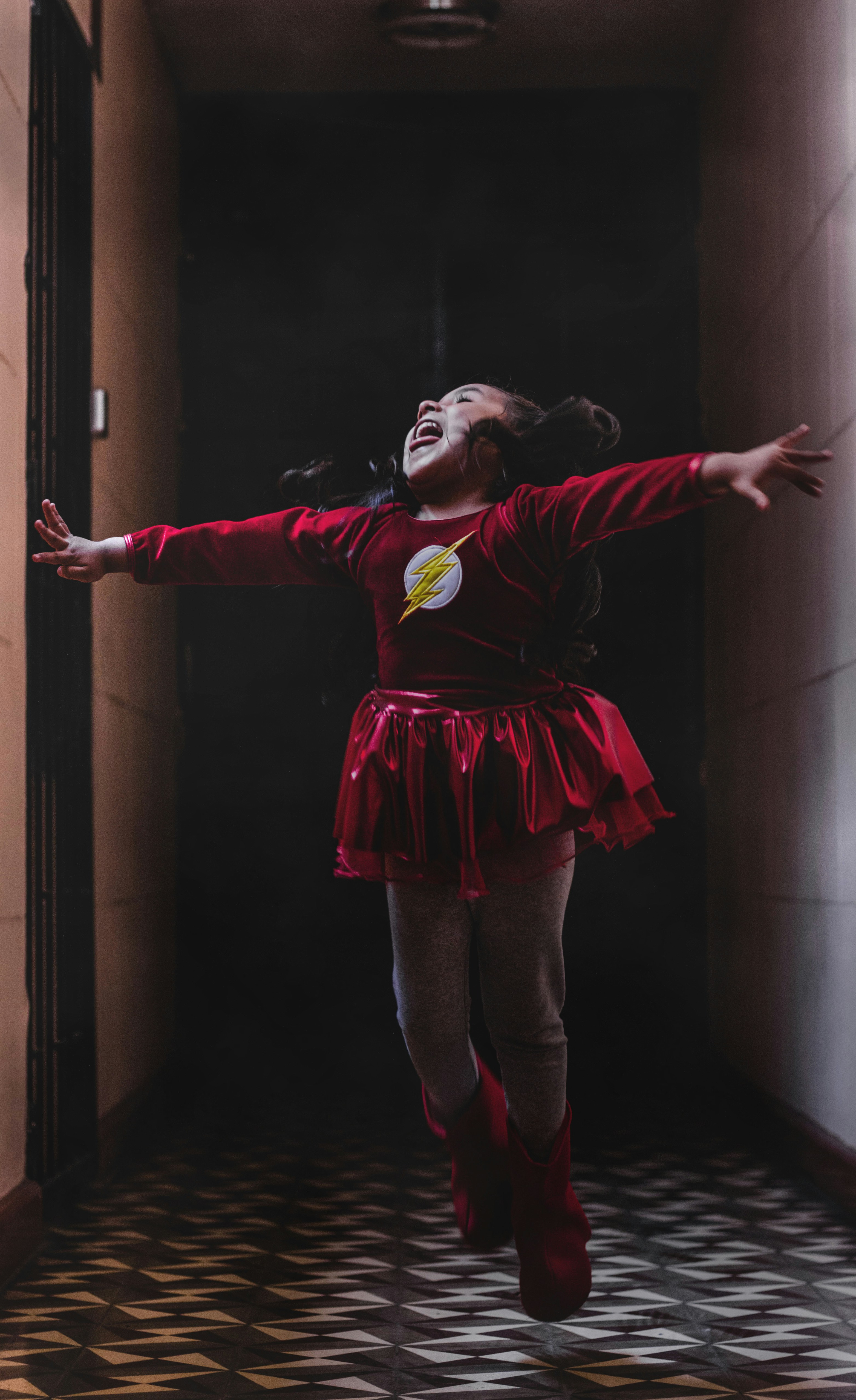 Laughing and jumping girl in DC Flash costume in room photo – Free ...