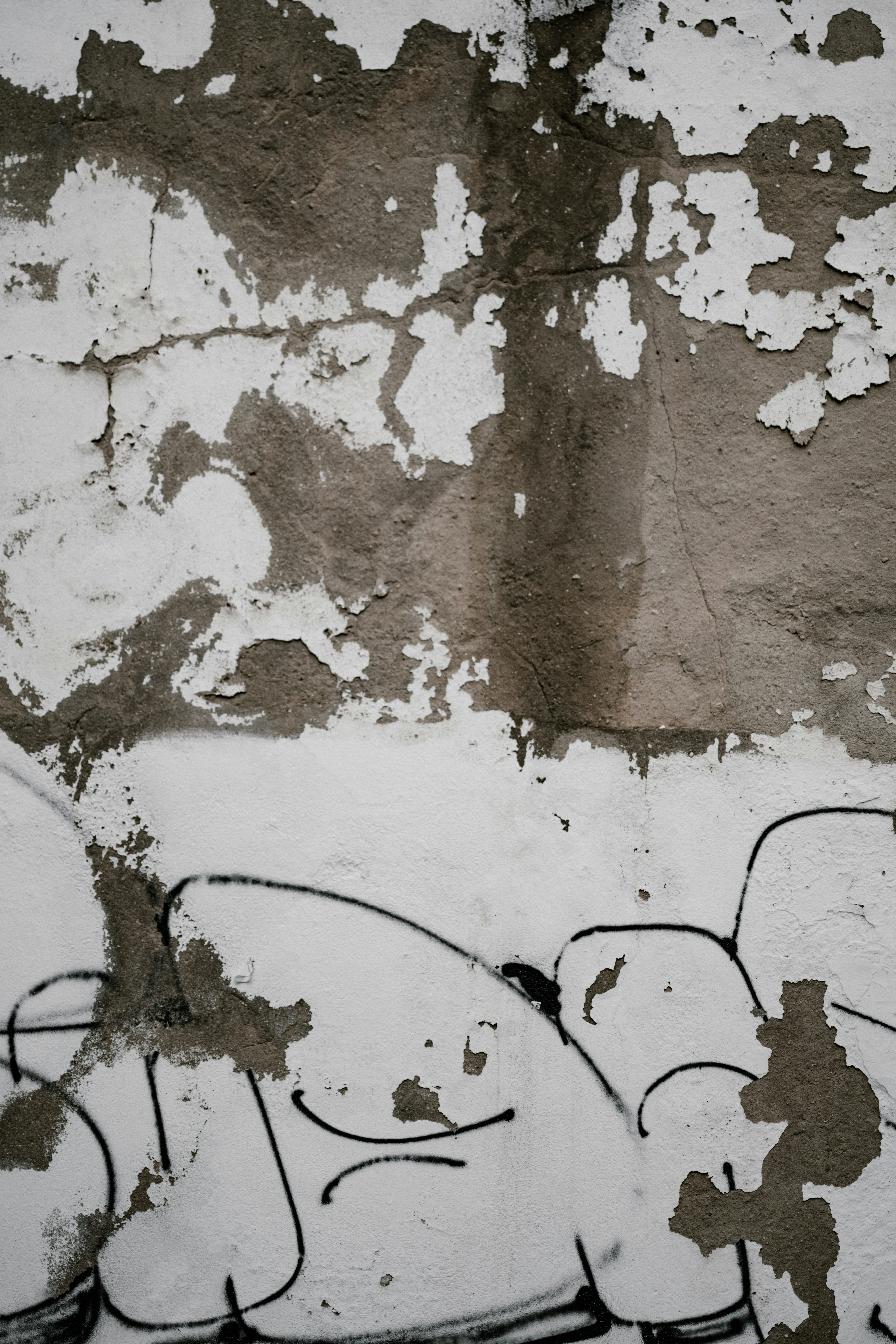 Old crumbling textured wall background | a wall with some graffiti on it