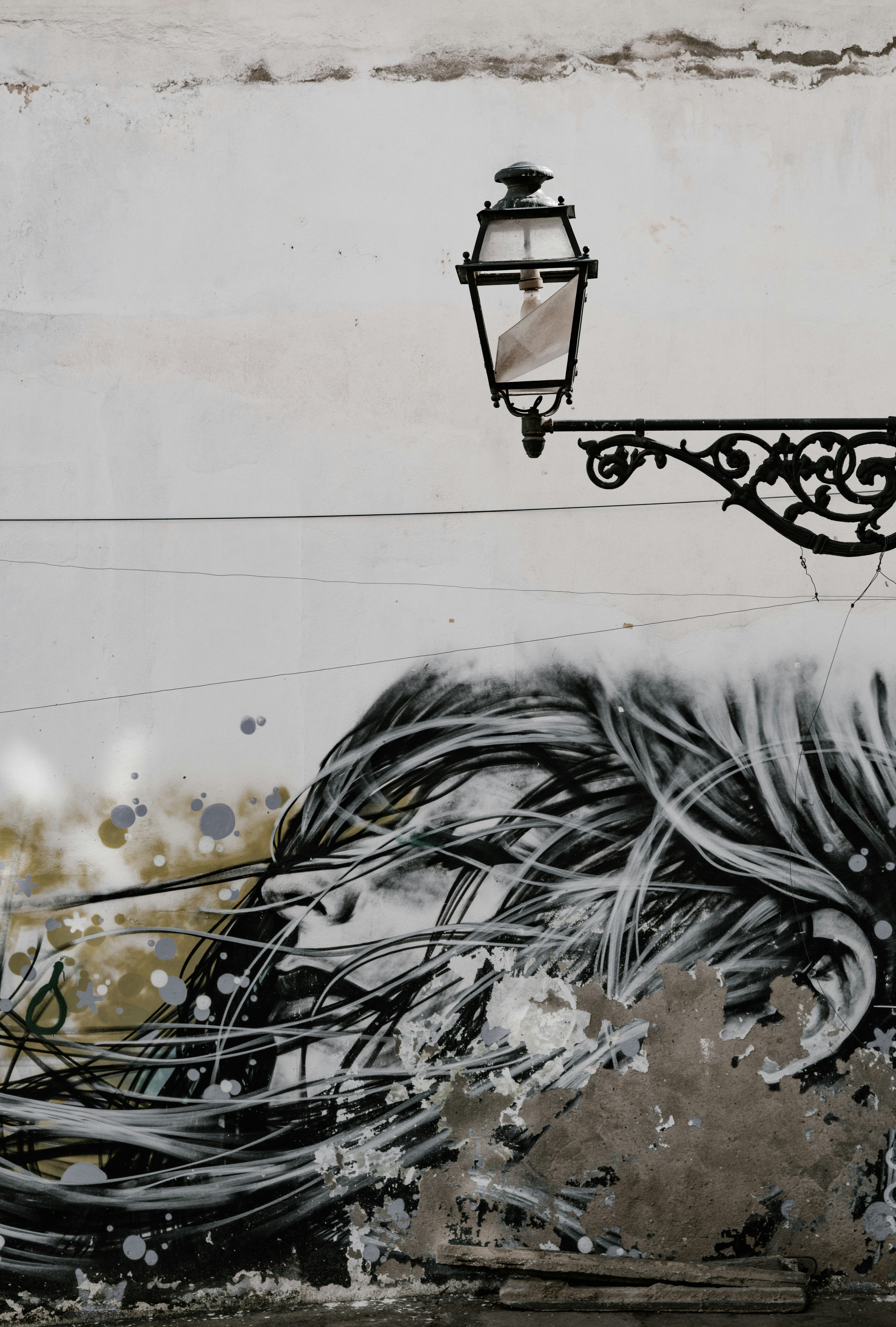 Lantern Over Monochrome Hair: A Street Mural in Motion