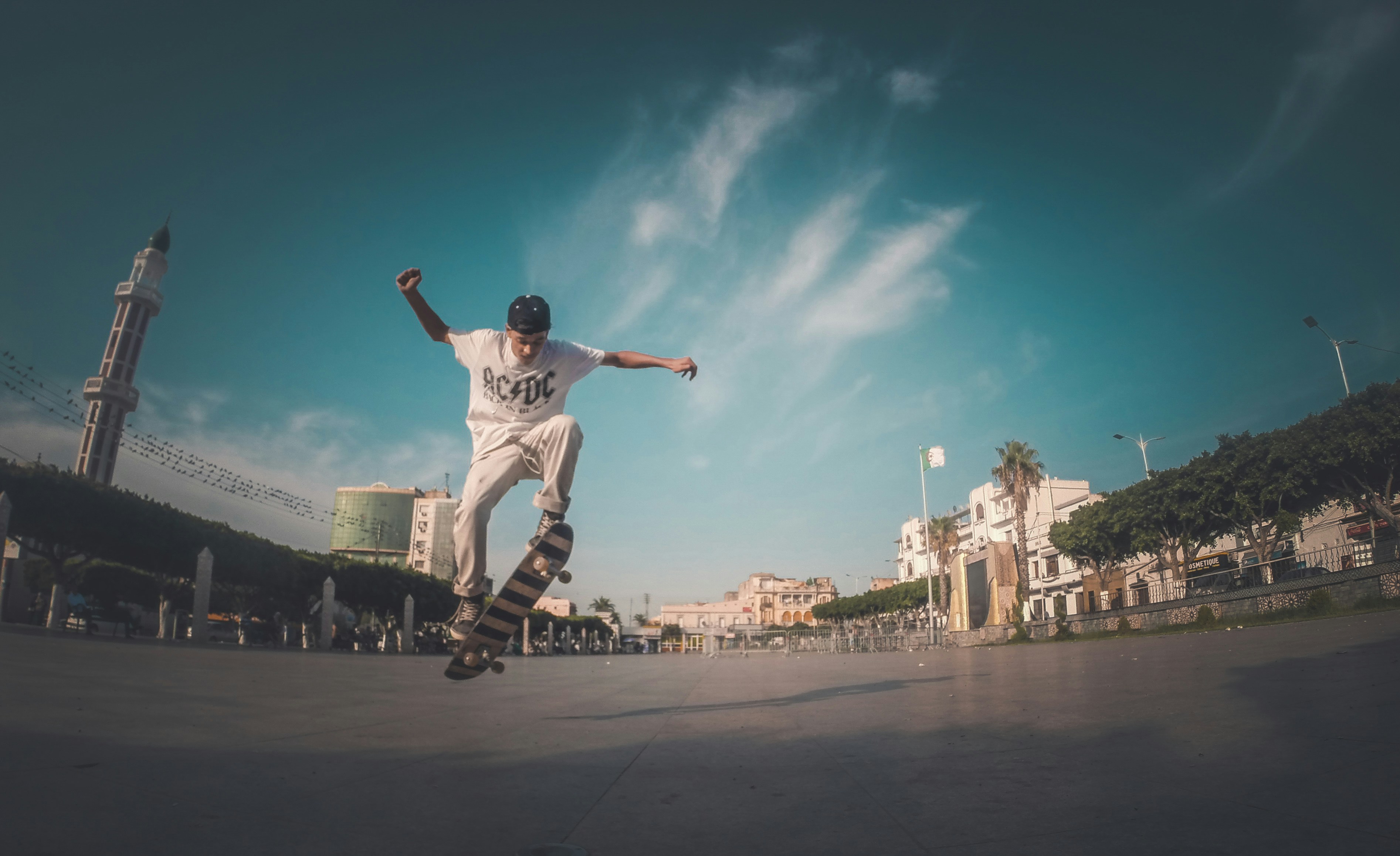Man skating on concrete road under blue and white skies photo – Free ...