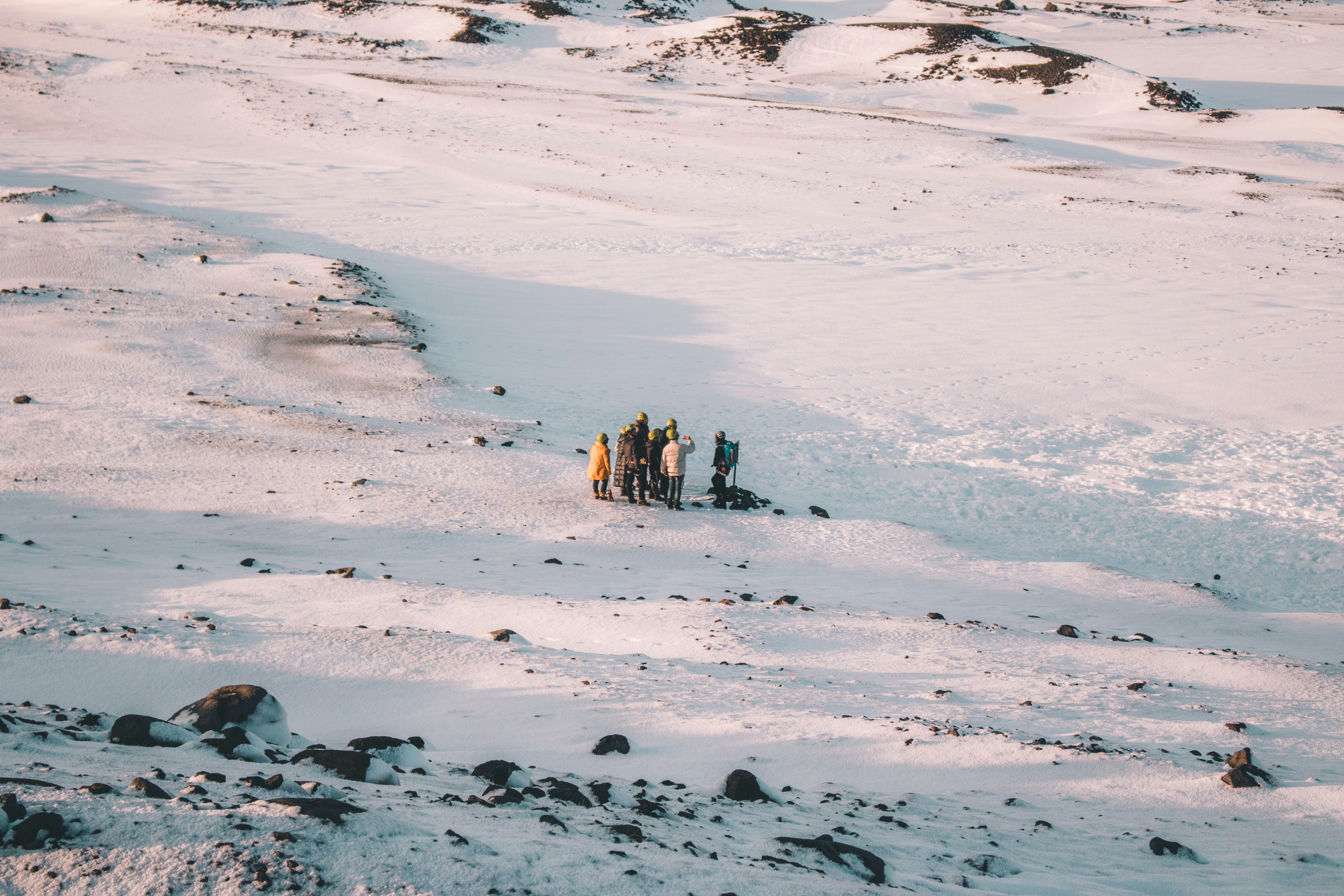 Glacial Crossing: Explorers Trek a Pale-Blue River Through Snow