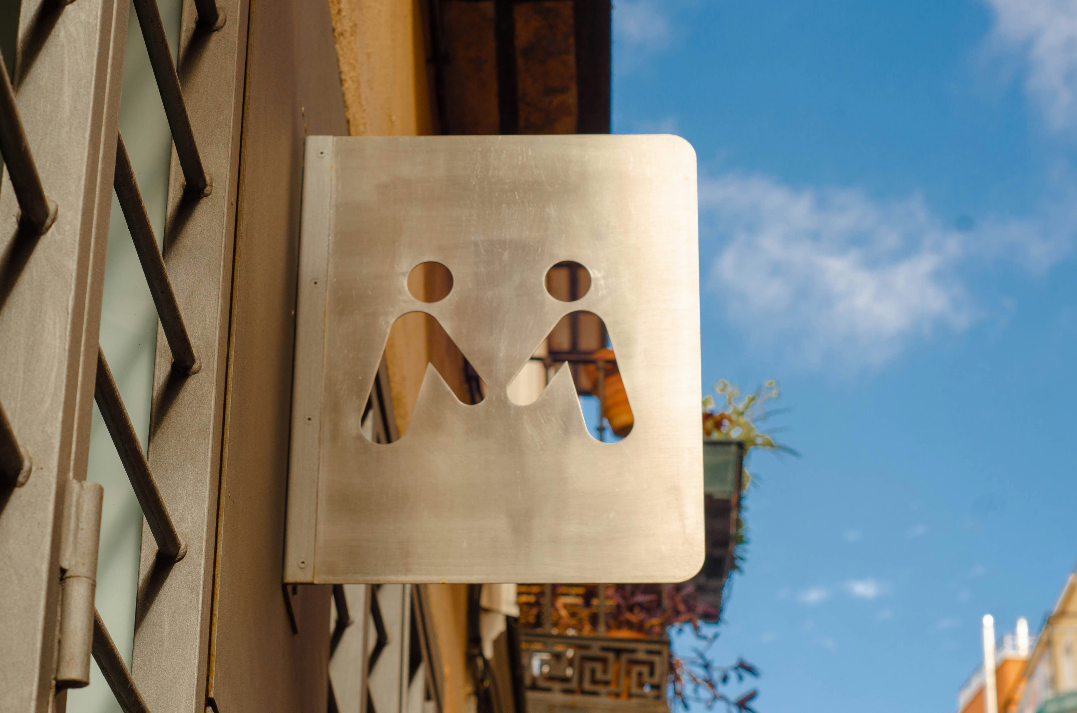 Sign | two person holding hands signage during daytime