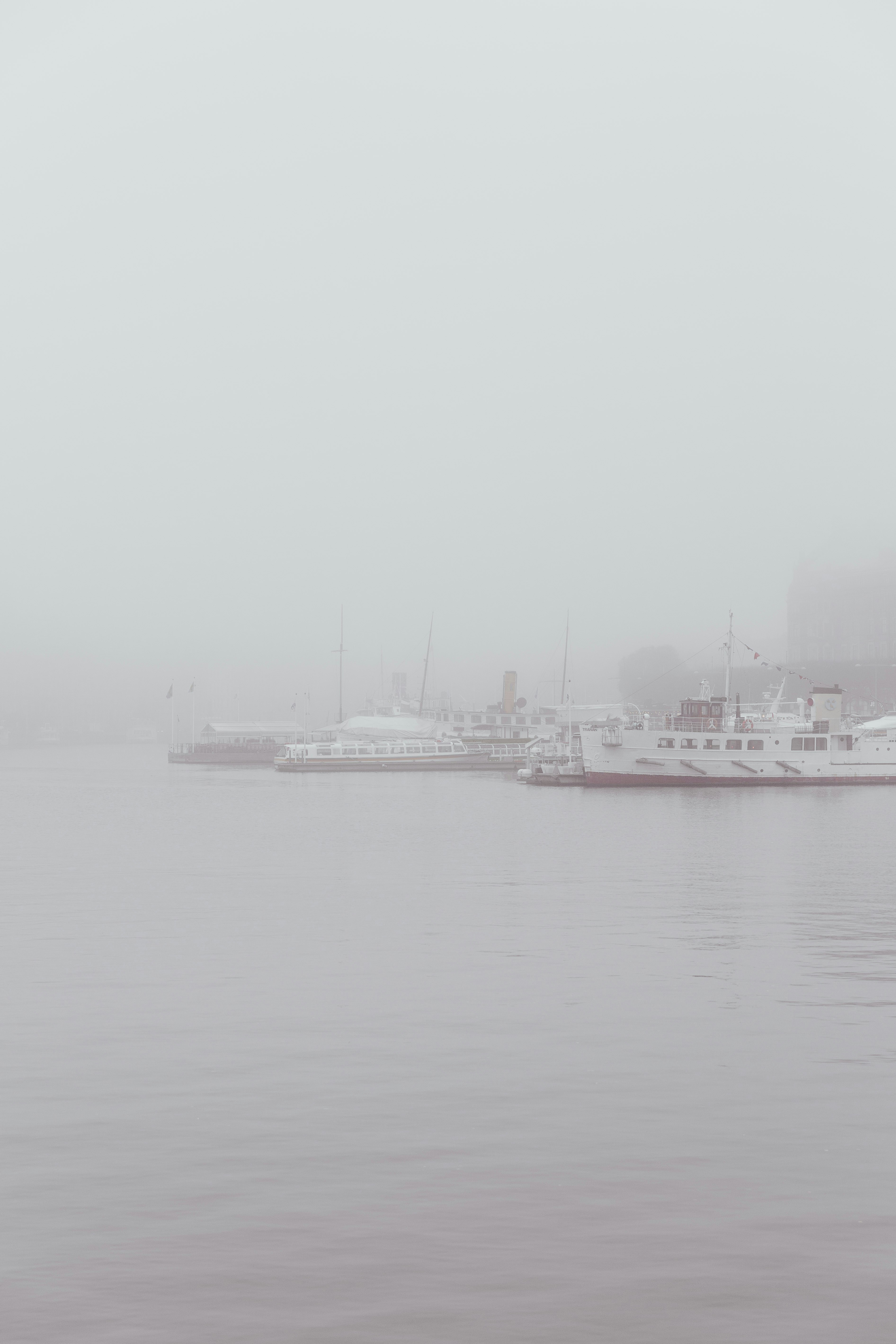Hushed Harbor in the Mist: Boats Rest in Quiet Fog