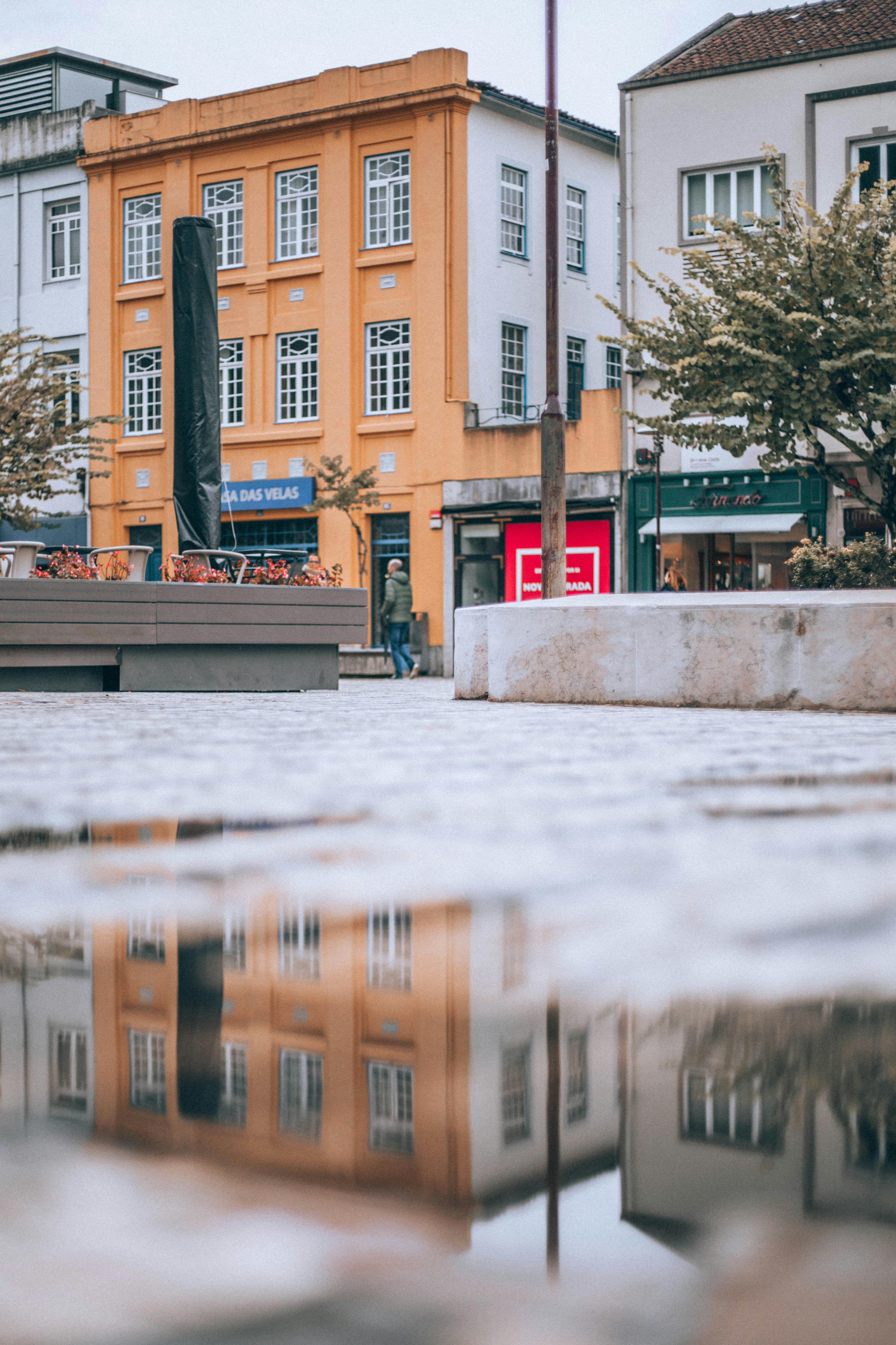 Amber Facades and the Quiet Mirror: A Street Scene in Perspective