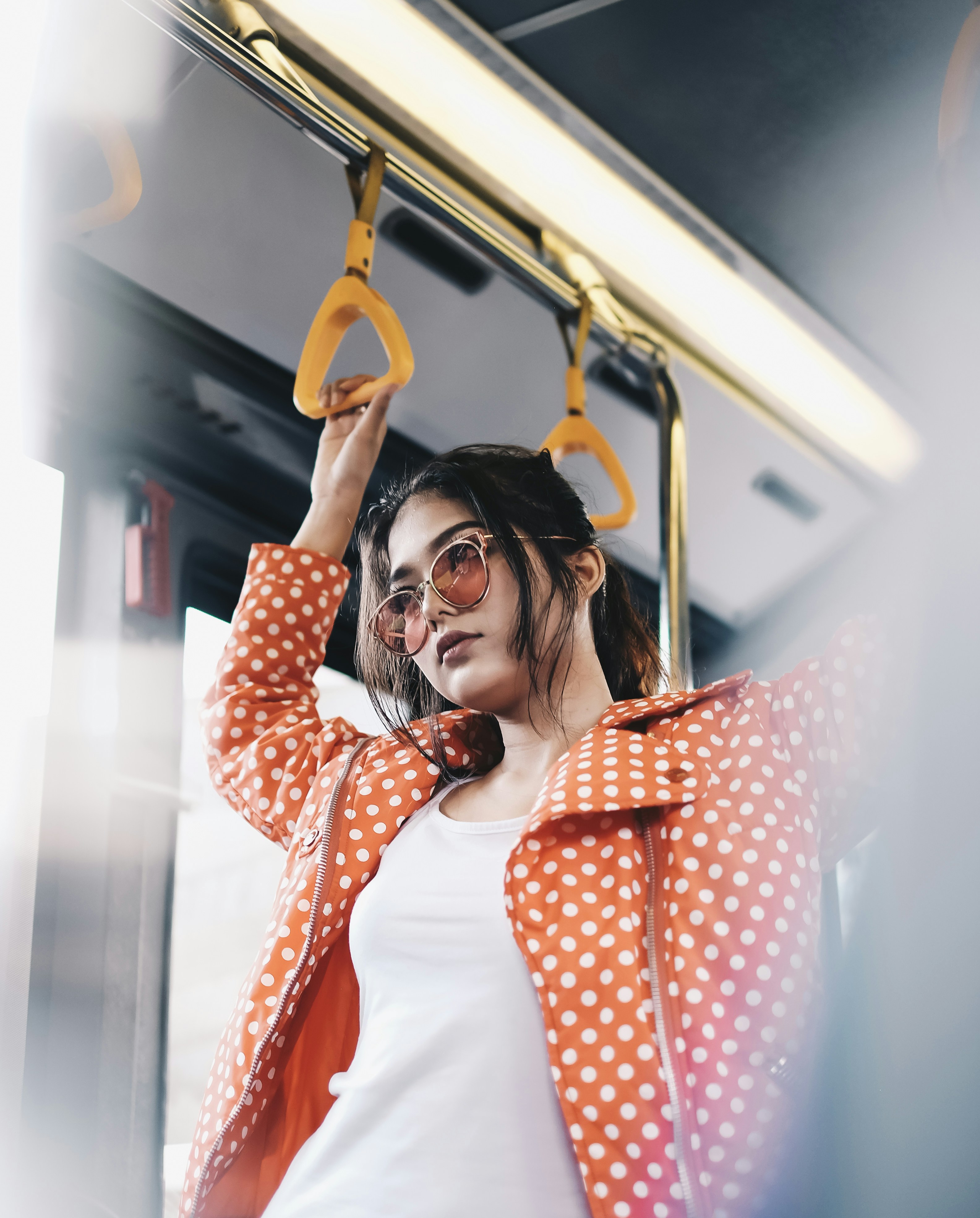 Polka-Dot Transit Moment: Quiet Confidence on a Moving Bus