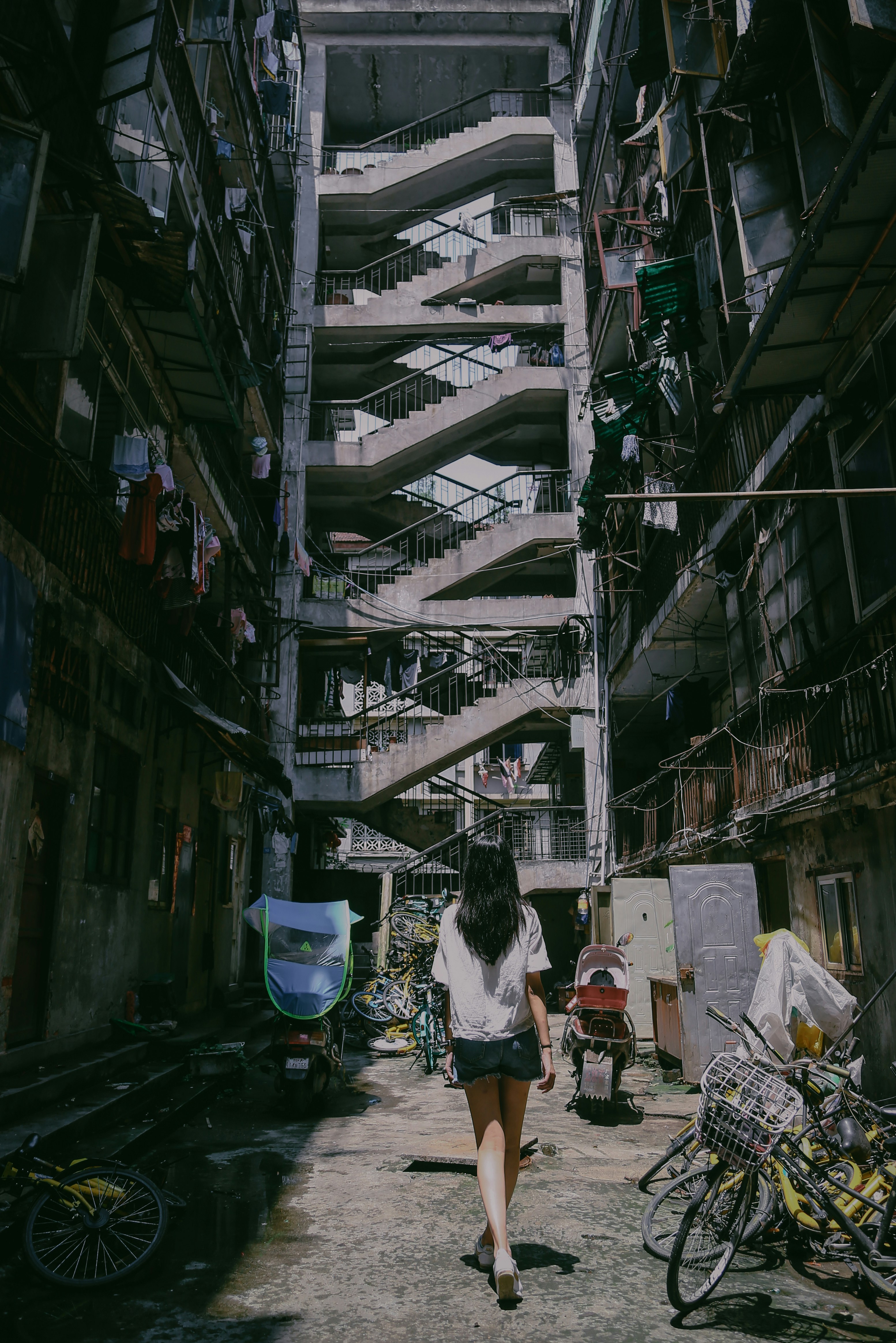 Urban Spiral: A lone walker marches through the concrete staircase canyon