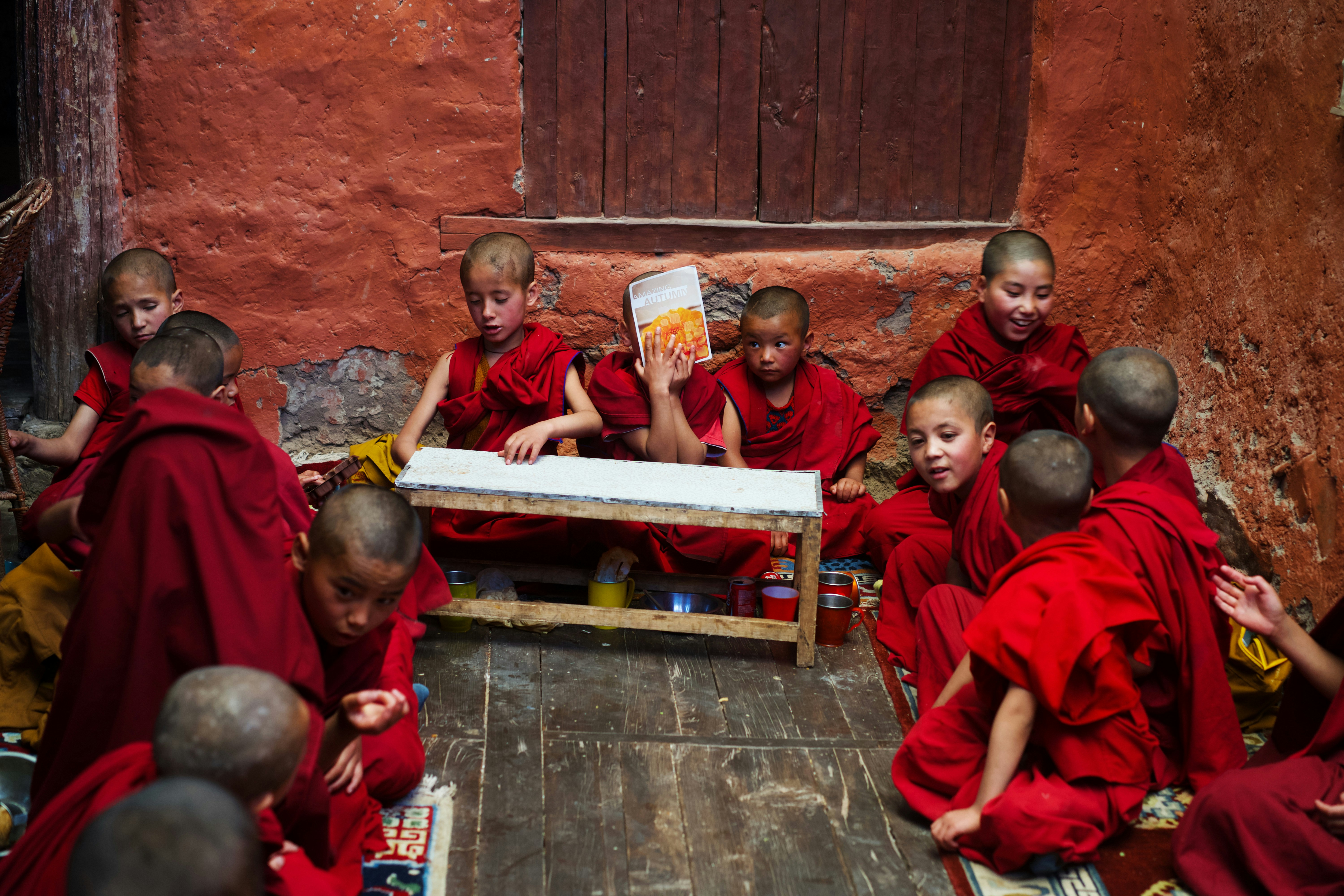 Boys in red robe sitting on the floor photo – Free Srinagar - ladakh ...