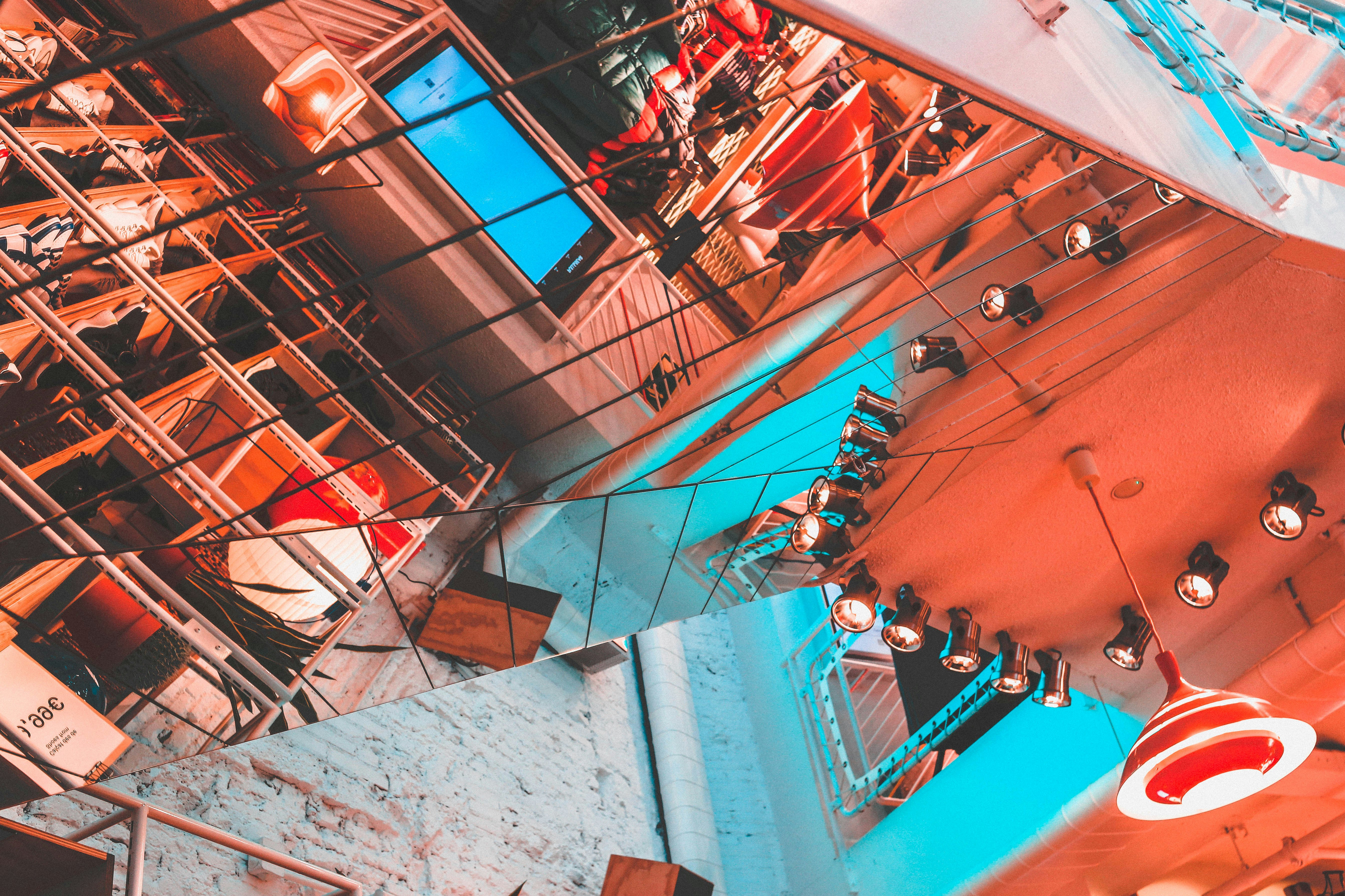 Crimson Atrium: Blue Neon Lines Framing a Labyrinth of Scaffolding