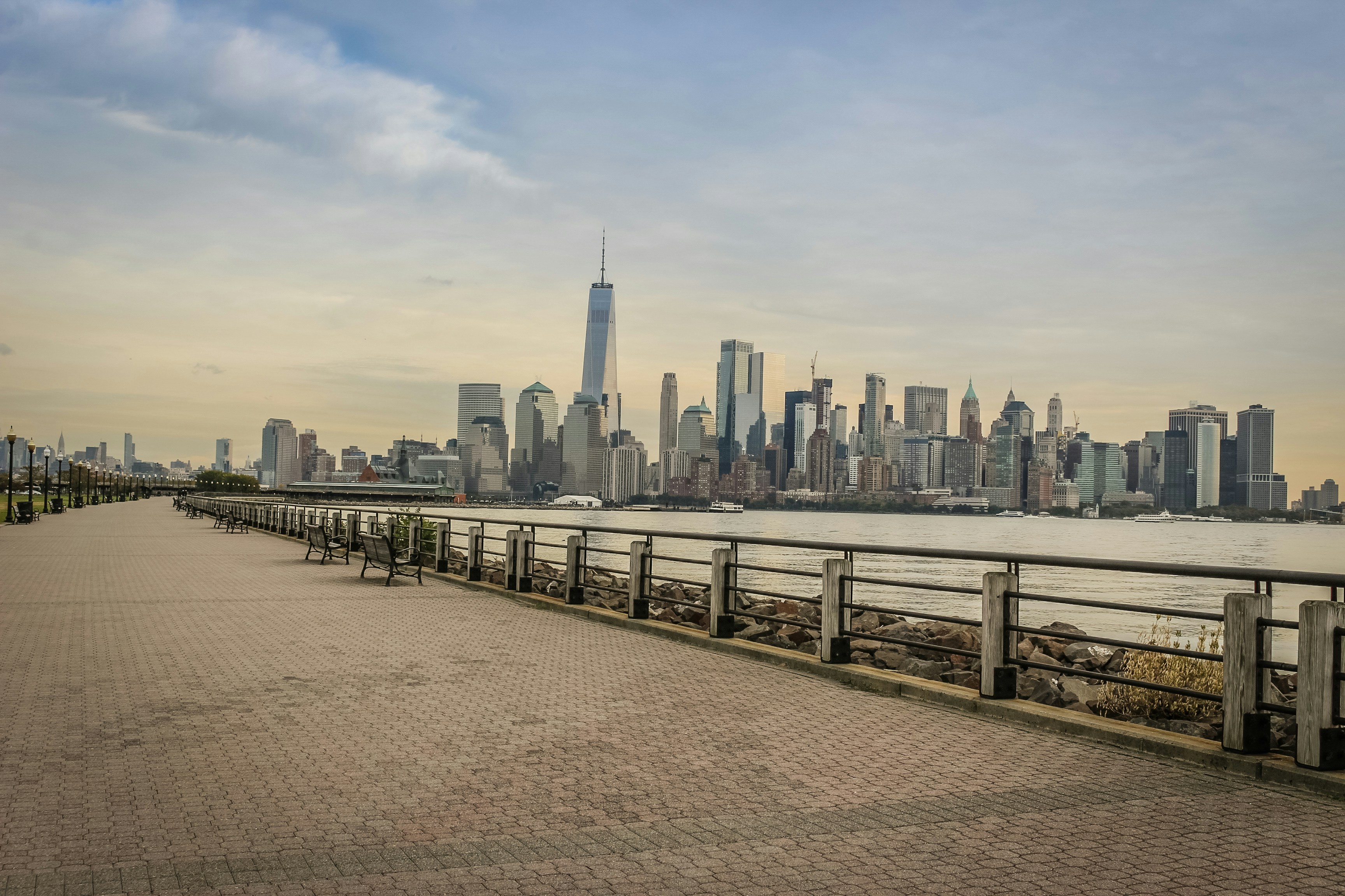 Empty railings and benches overlooking buildings in skyline photography ...