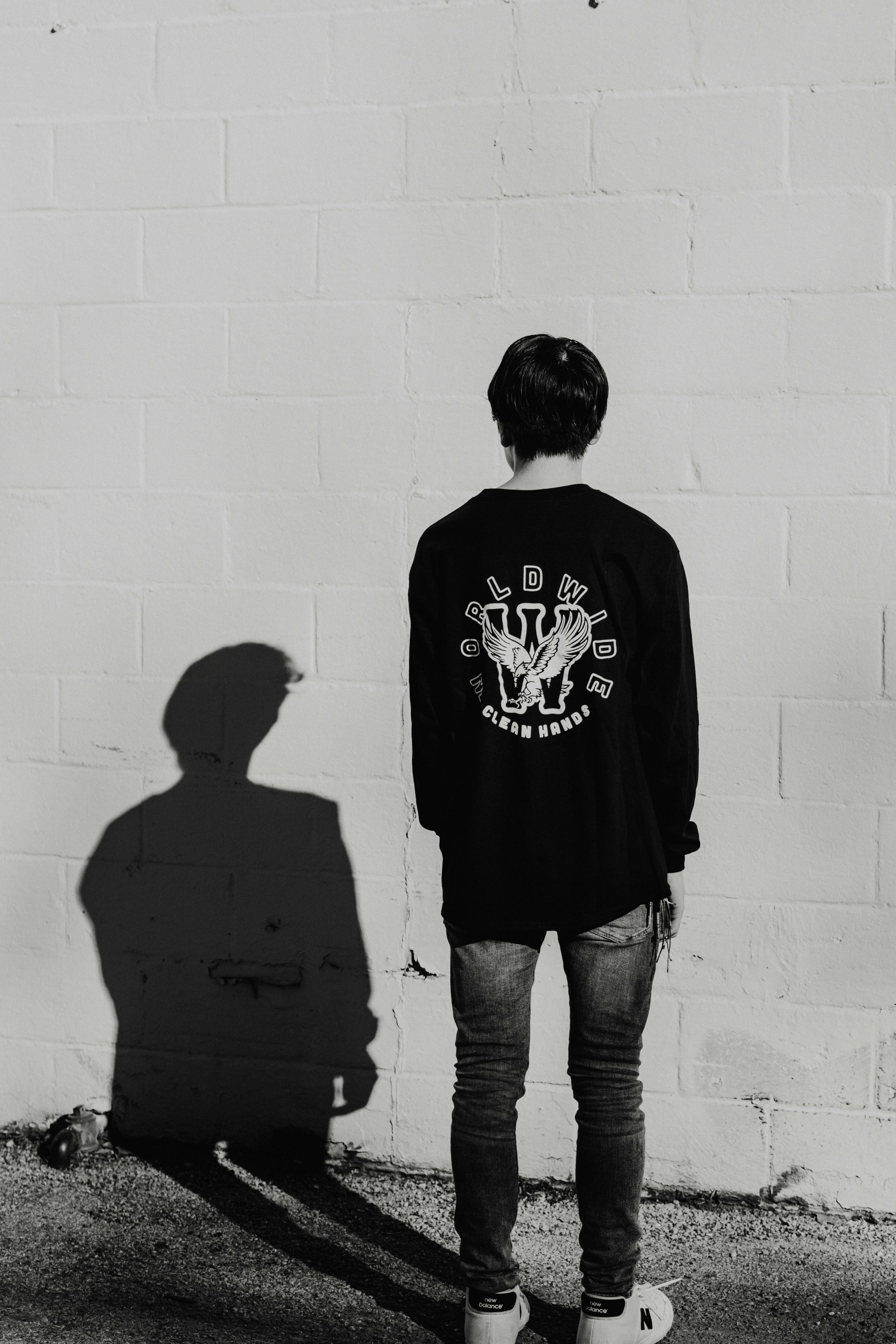 Man standing and facing back near wall photo – Free Fashion Image on ...