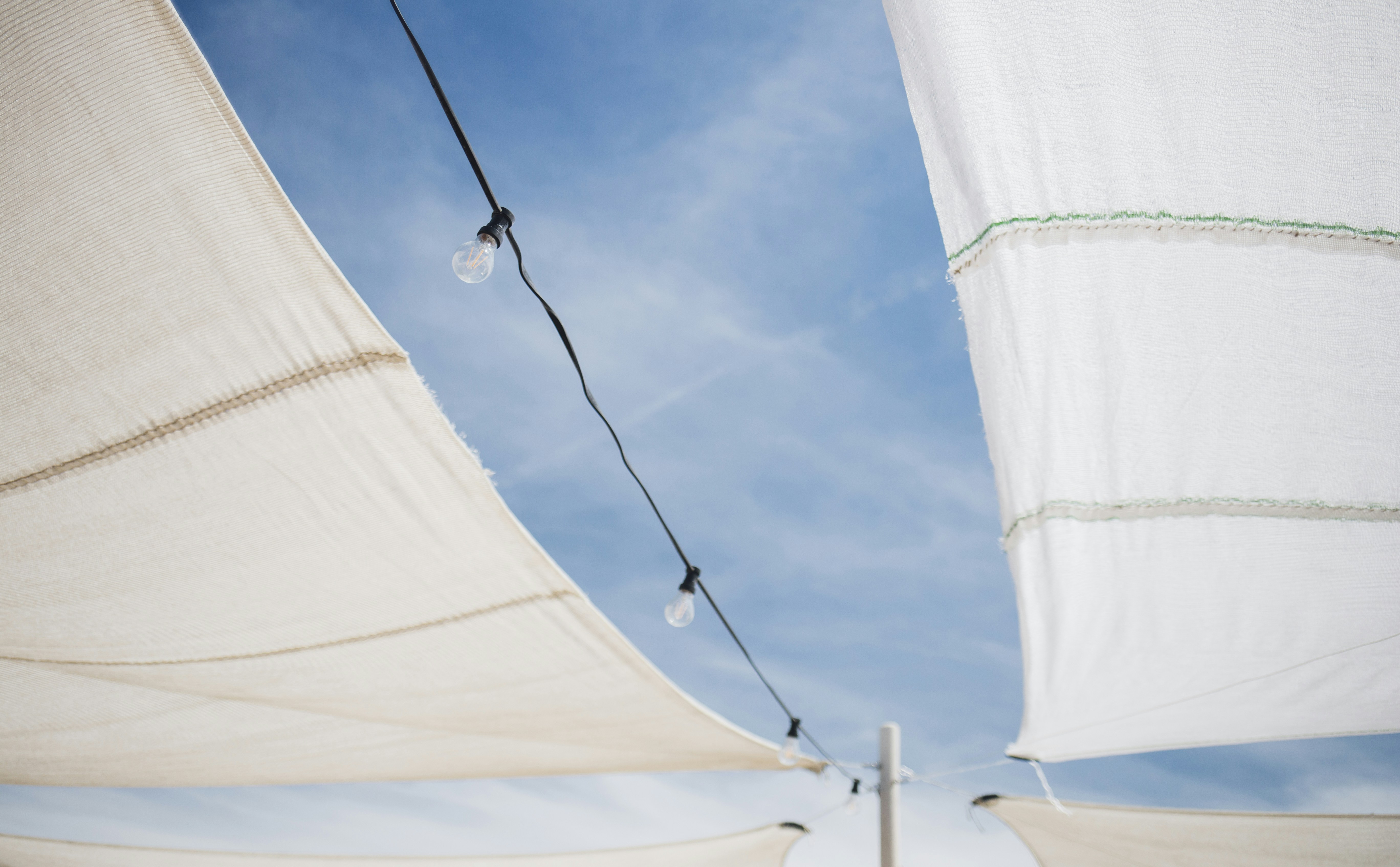 White textiles and light bulbs on ropes photo – Free Grey Image on Unsplash