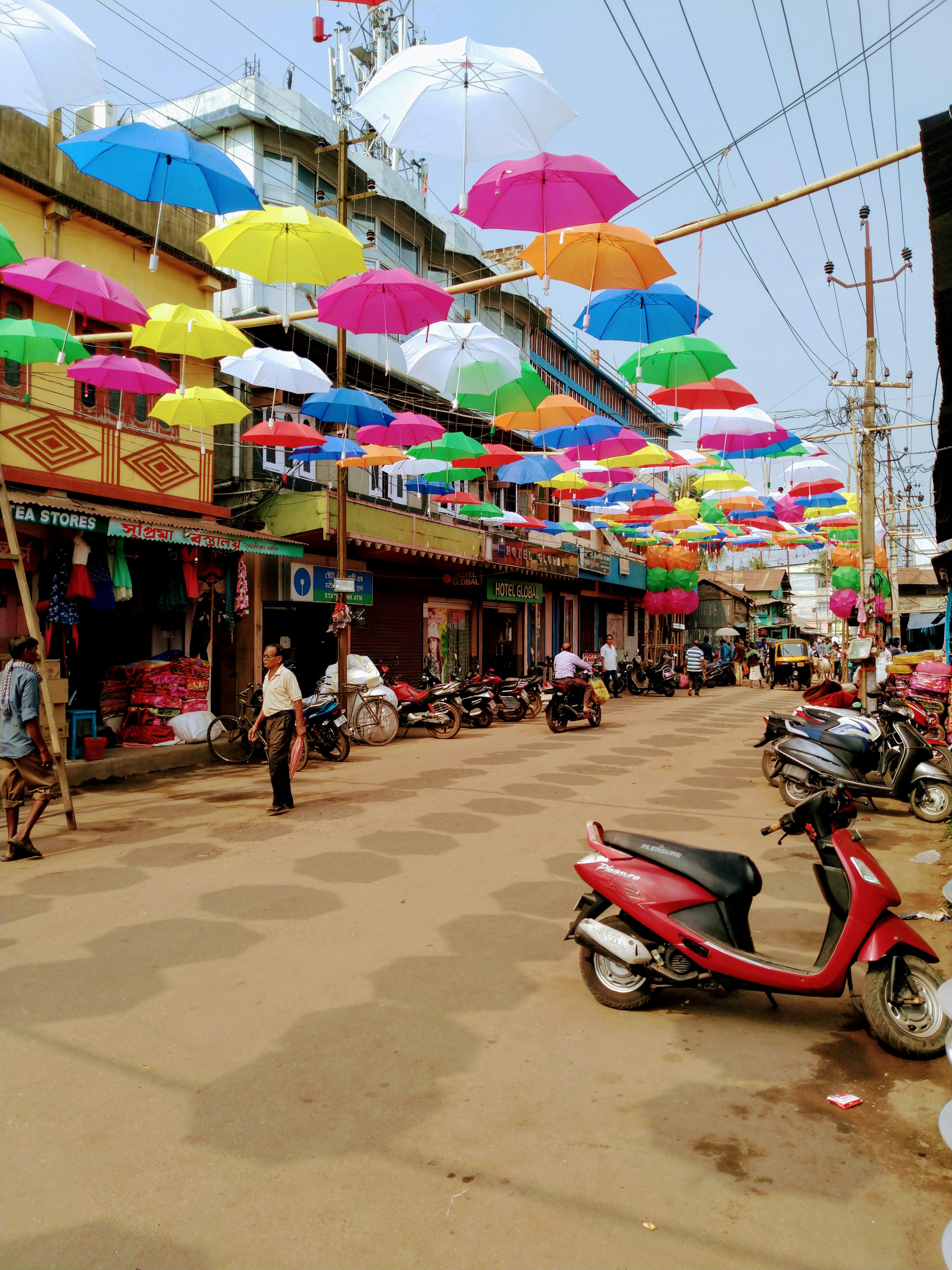 Man standing in front of storefront under opened umbrellas photo – Free ...