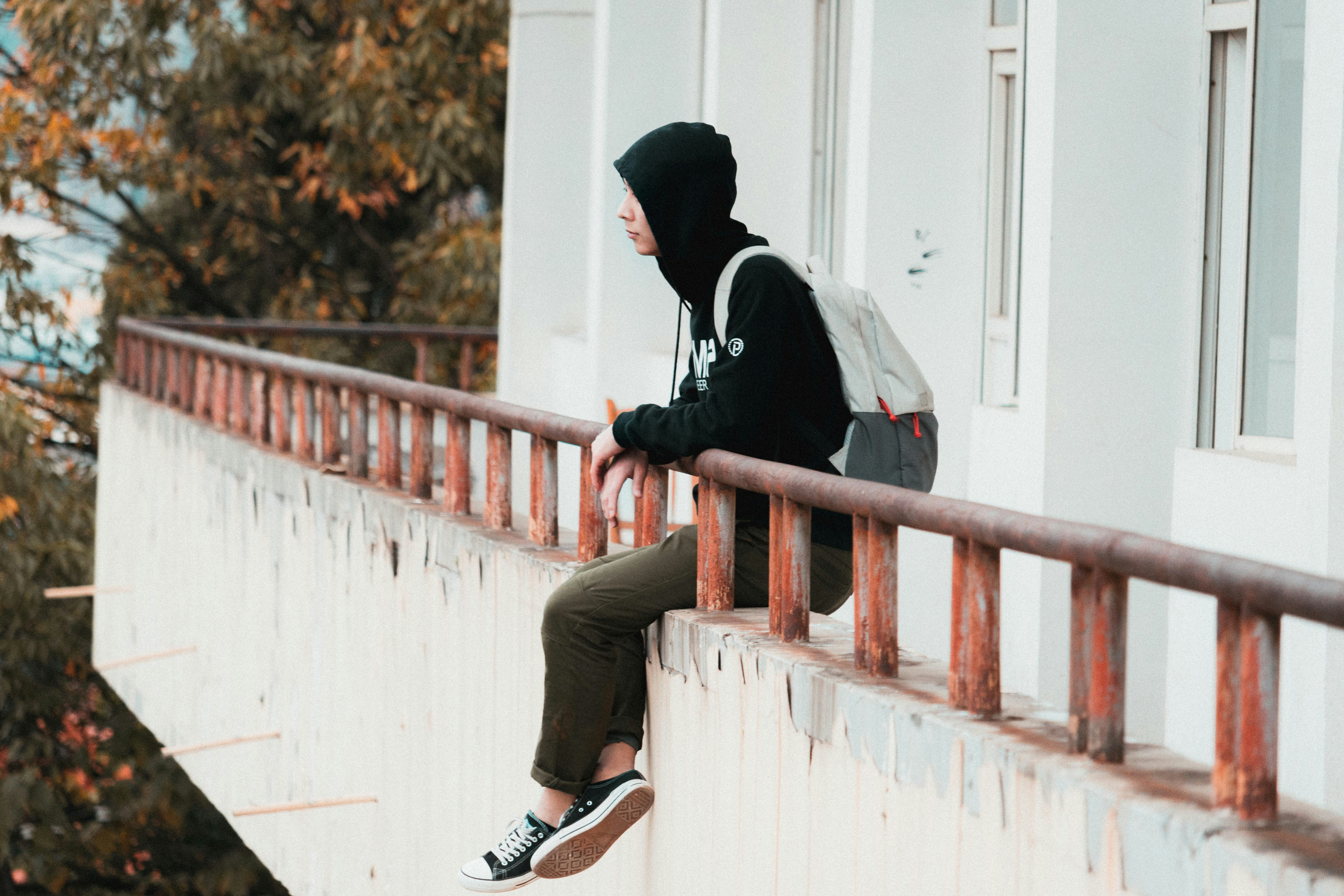 Person sitting on white concrete rail during daytime photo – Free Human ...