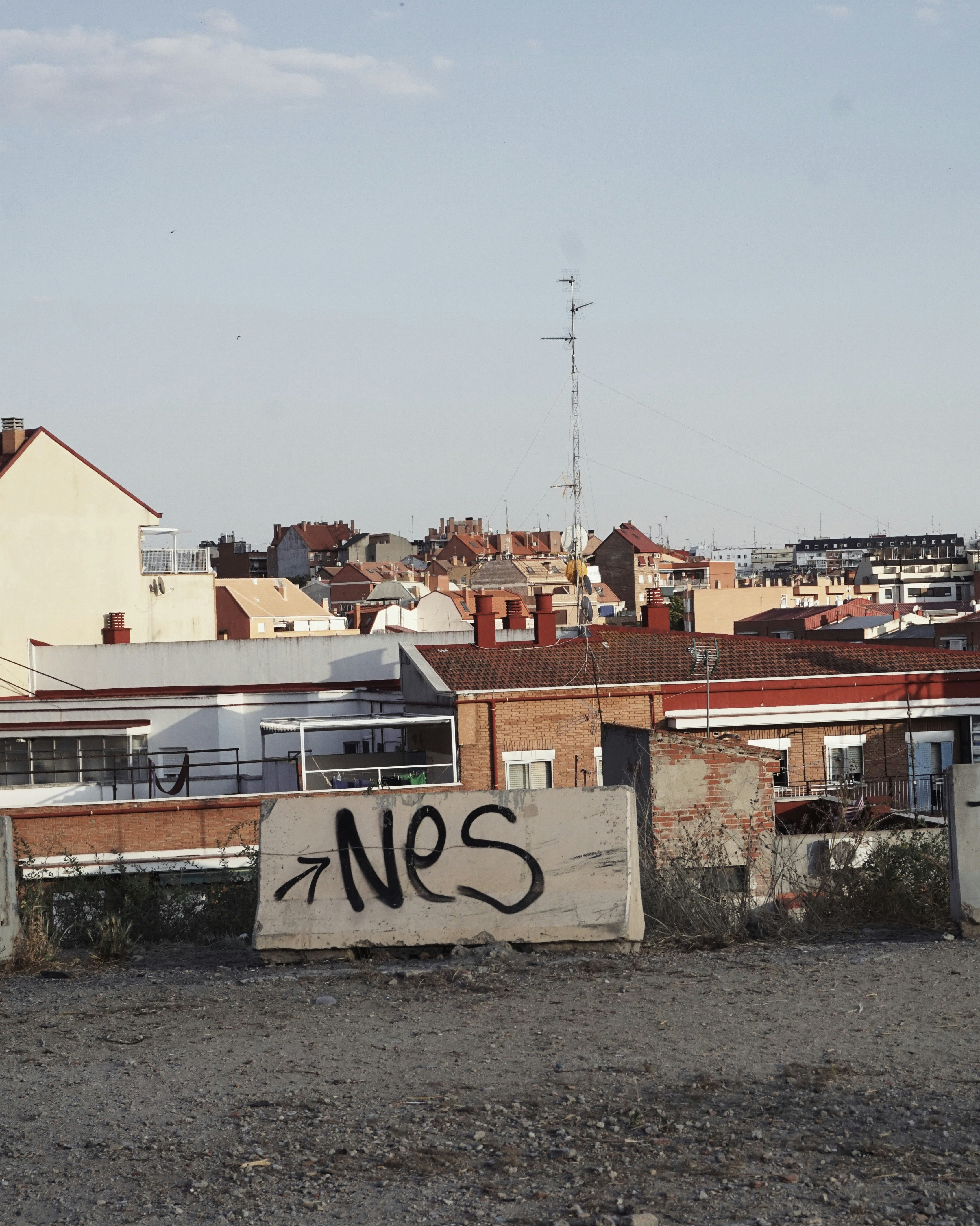 NES Tag Framed by a Rooftop Cityscape and a Central Antenna