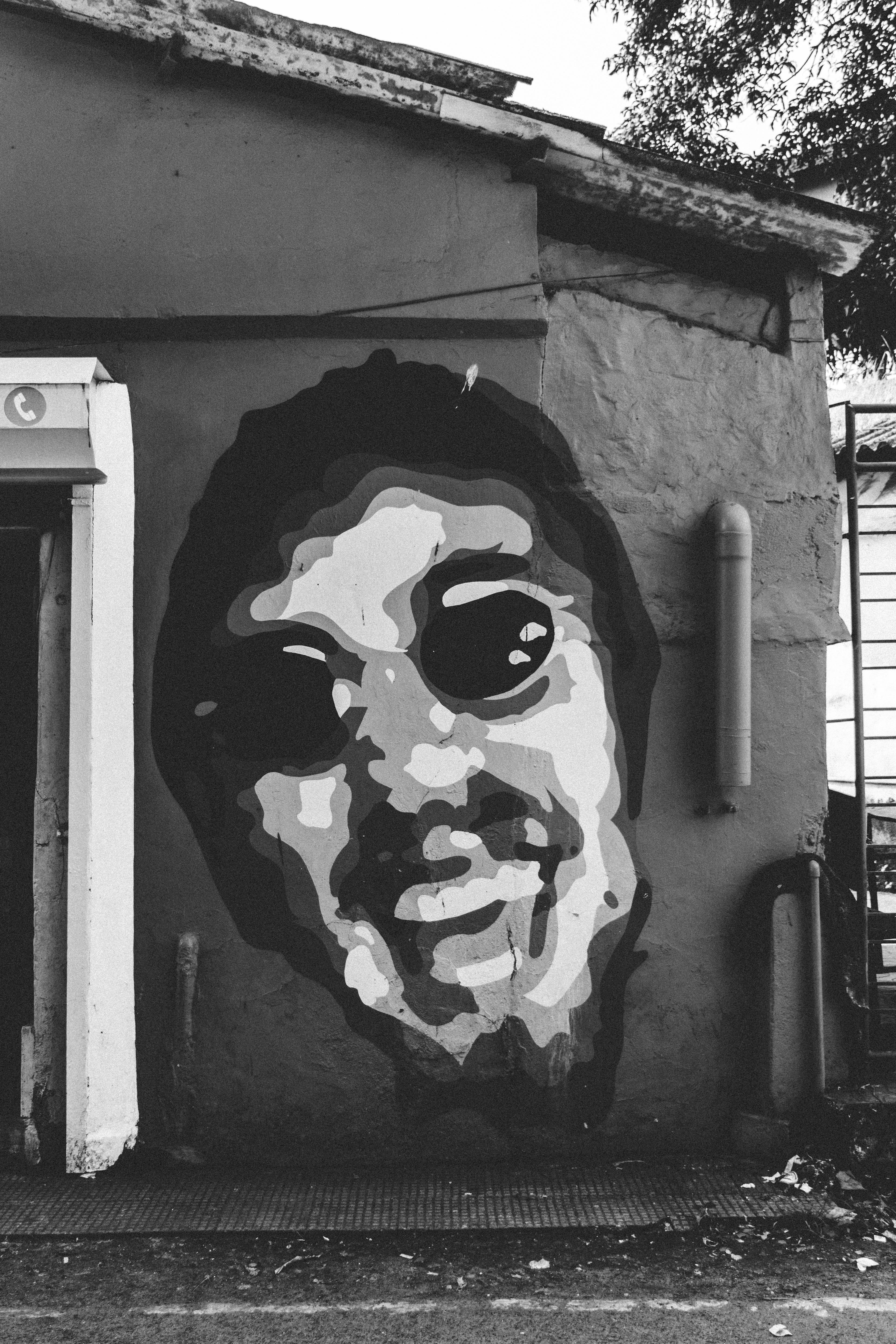 Cheerful Silhouette: The Bold Face Portrait on a Weathered Wall