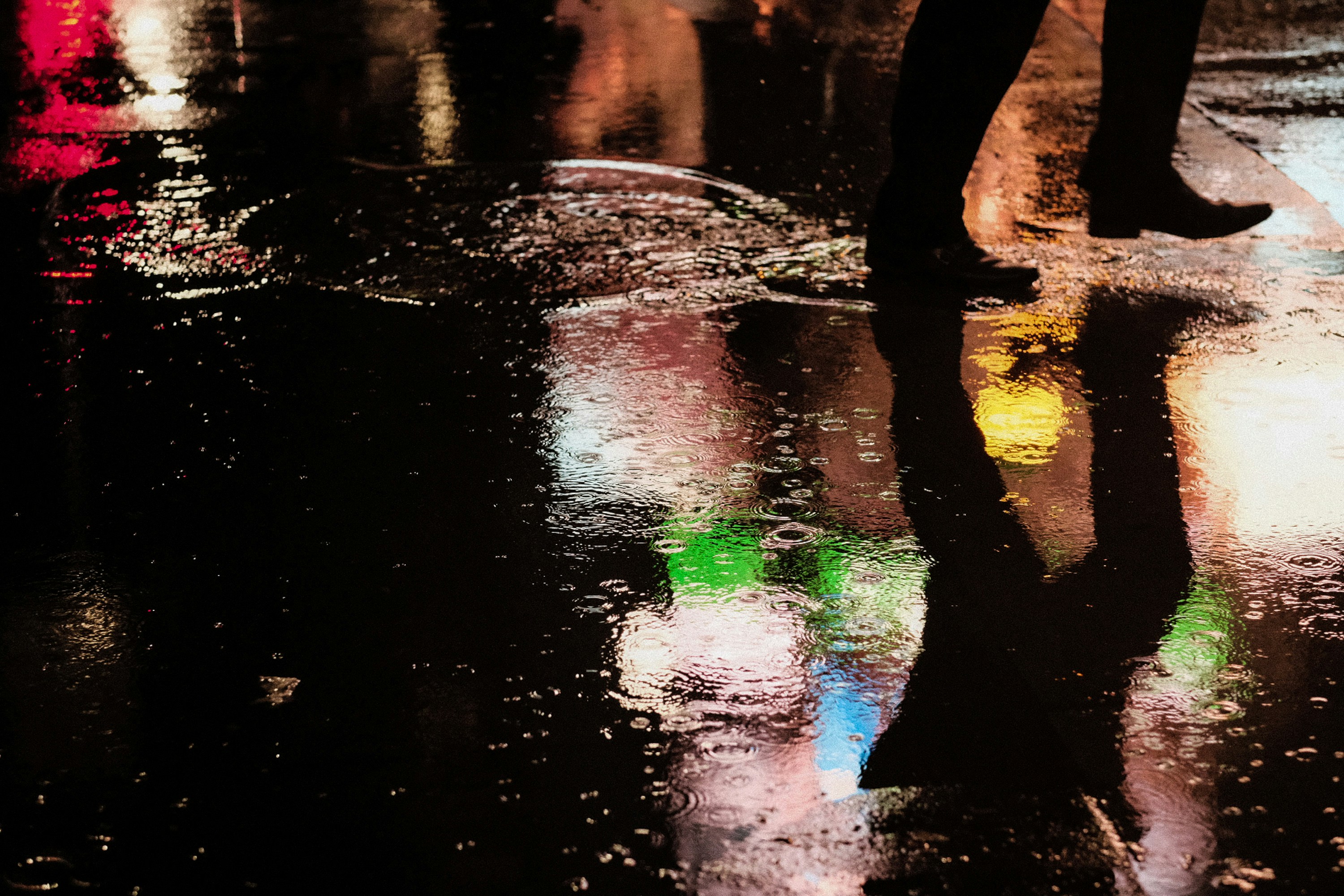 Footsteps in Neon Rain: Reflections on a Shimmering City Street
