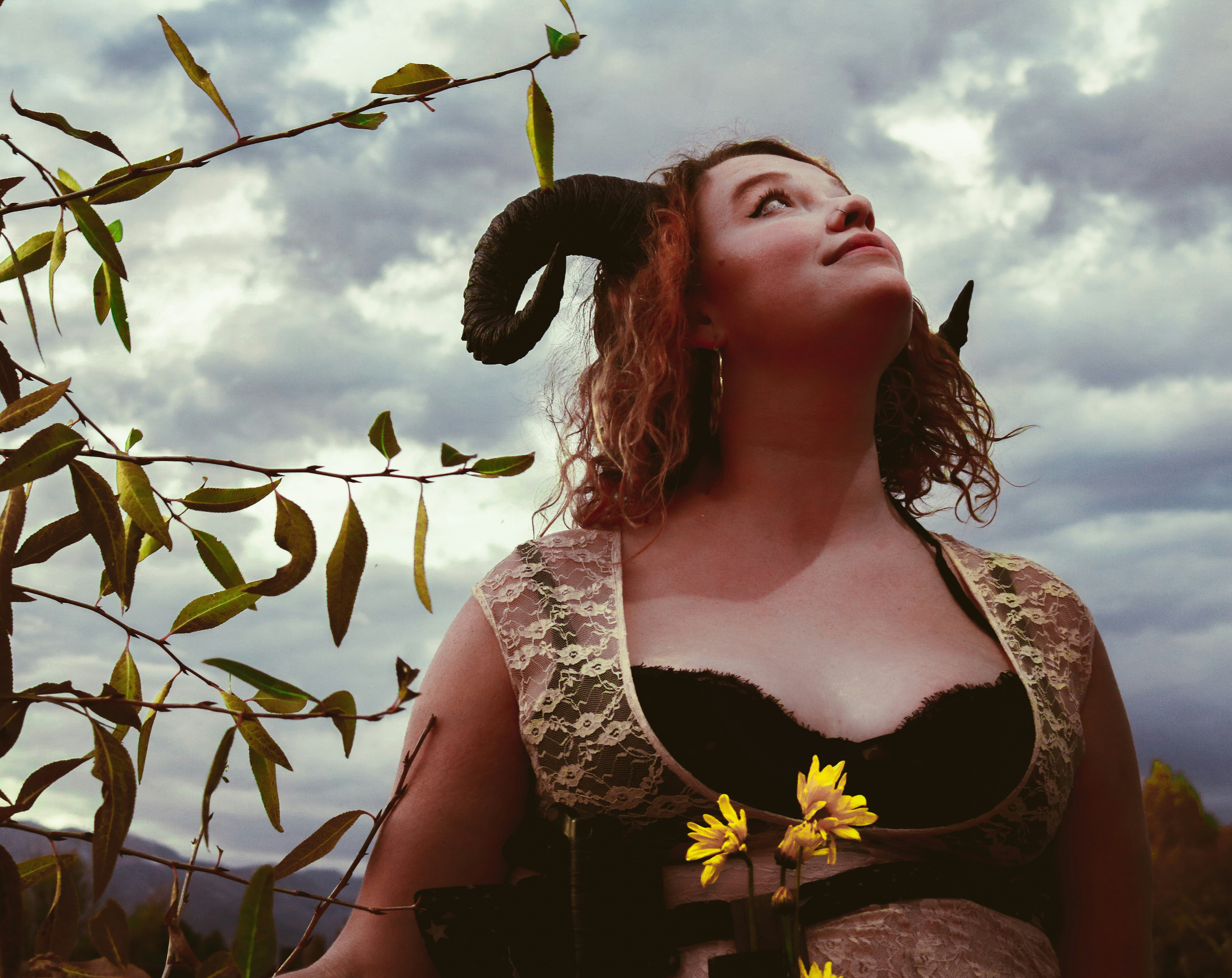 Horned Portrait Amid a Storm-tinged Sky and Wildflowers