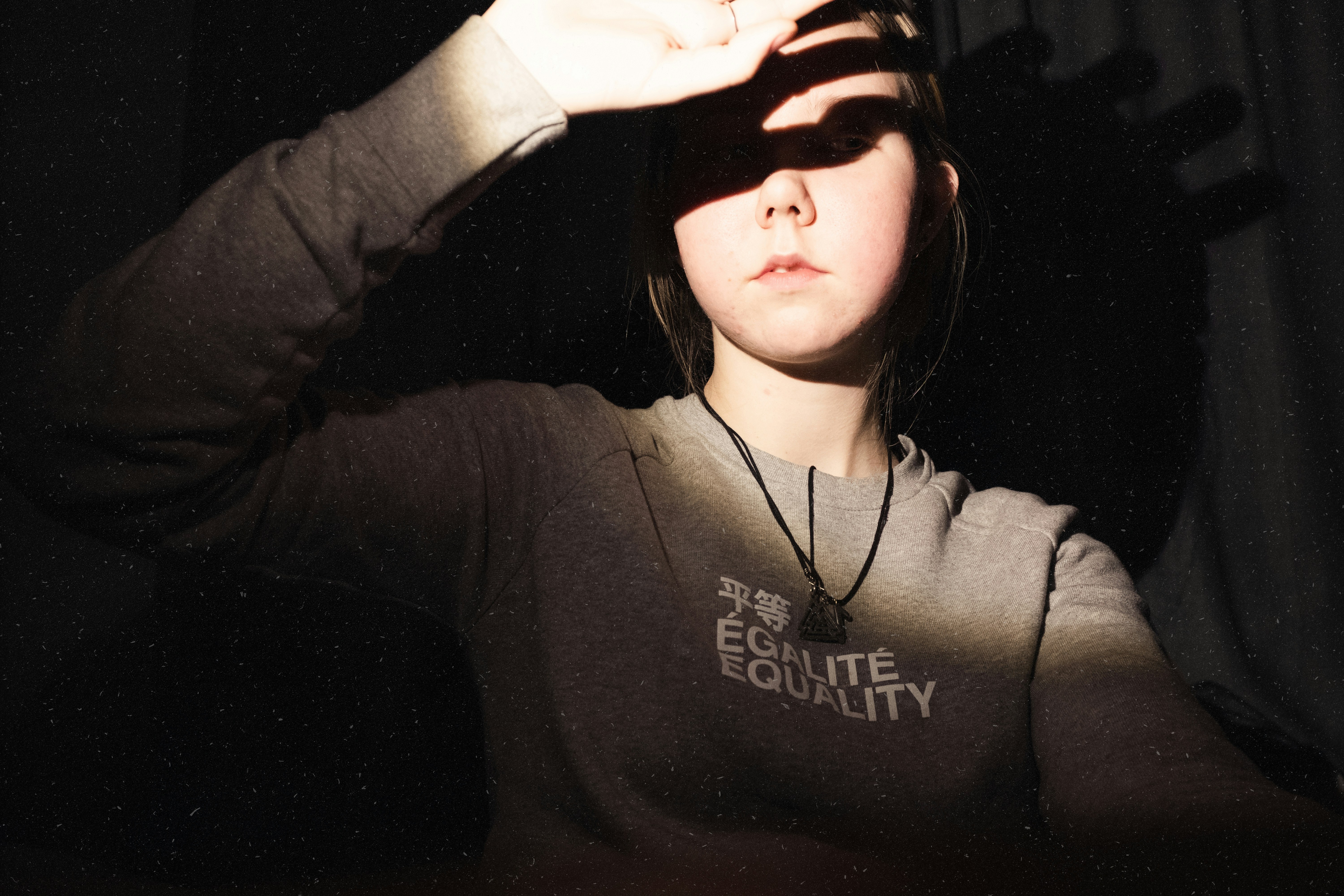 Shadowed Gaze in a Dusty Spotlight