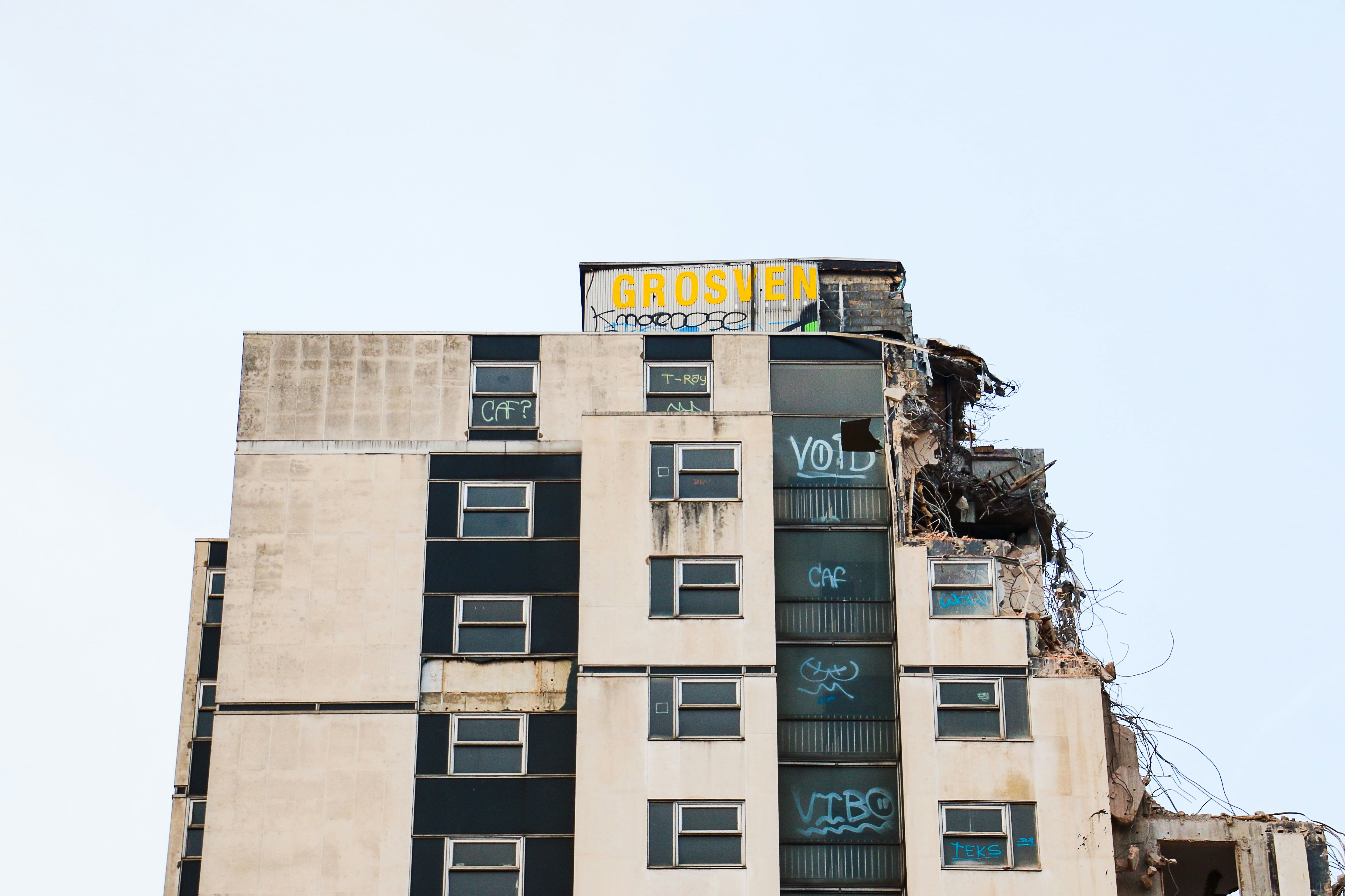 Grosven Hotel Demolition | white and black building during daytime