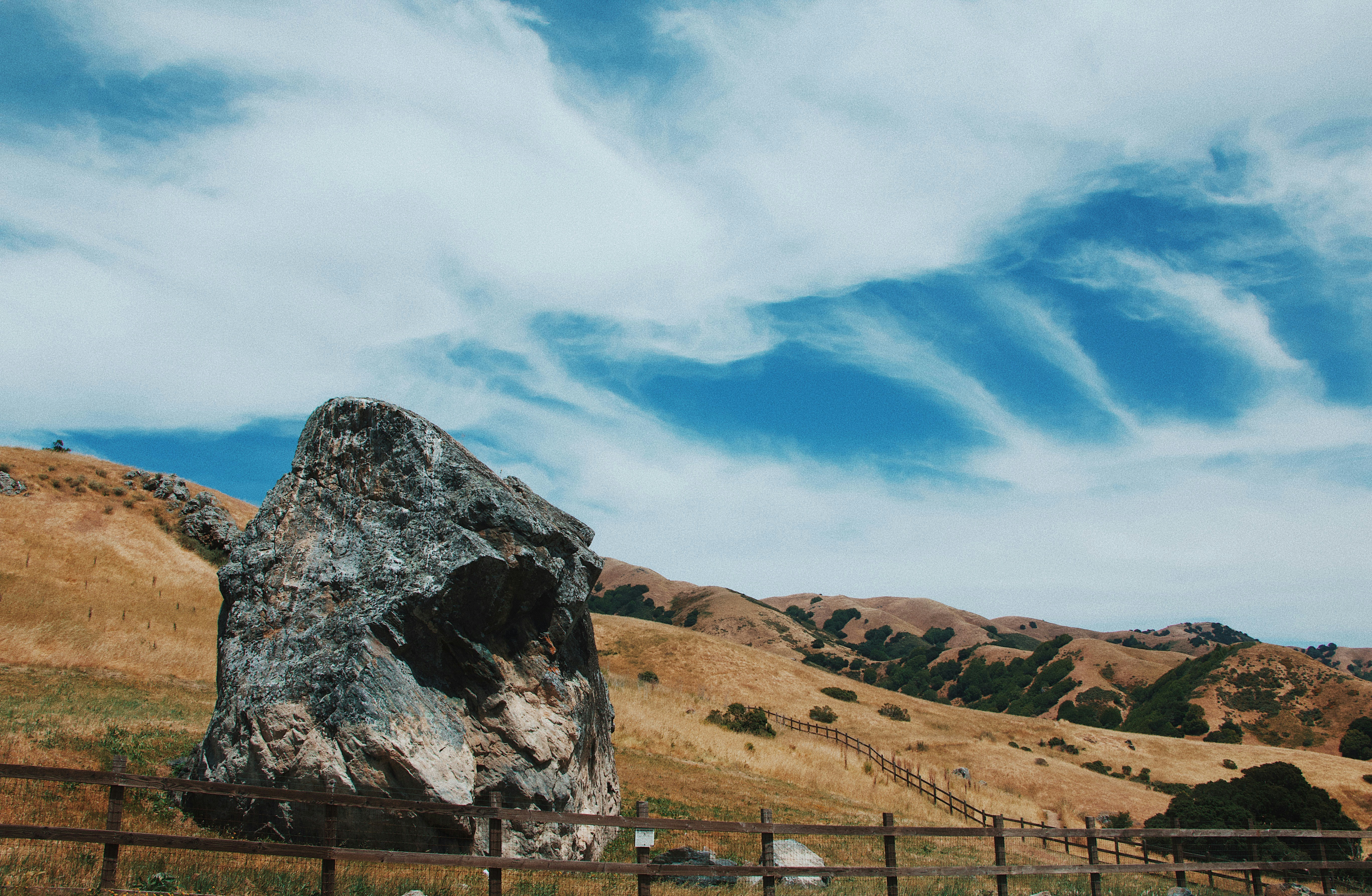 Granite Sentinel Over a Sunlit Prairie Ridge