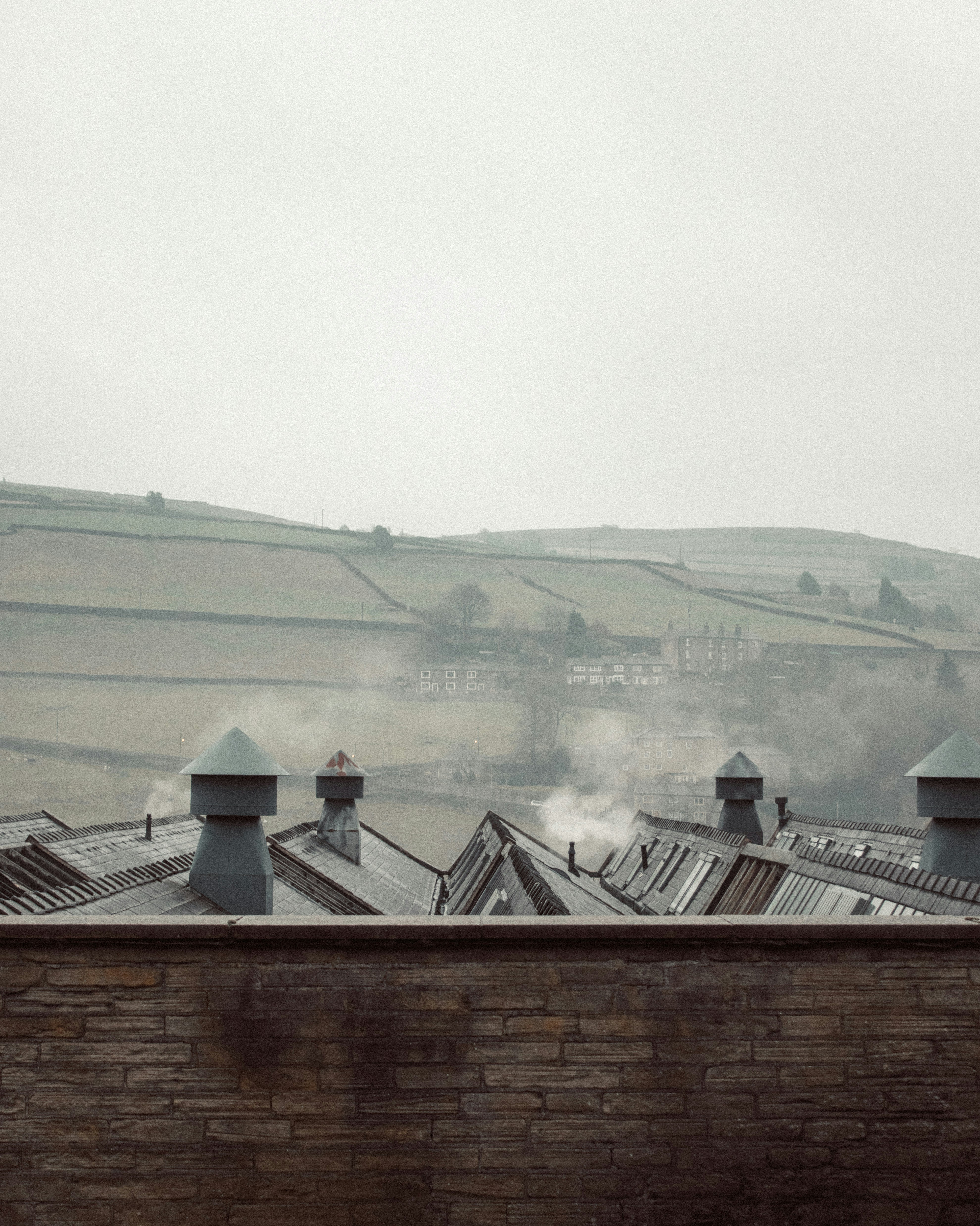 Ridge of Steam: Chimneys Crown a Misty Valley