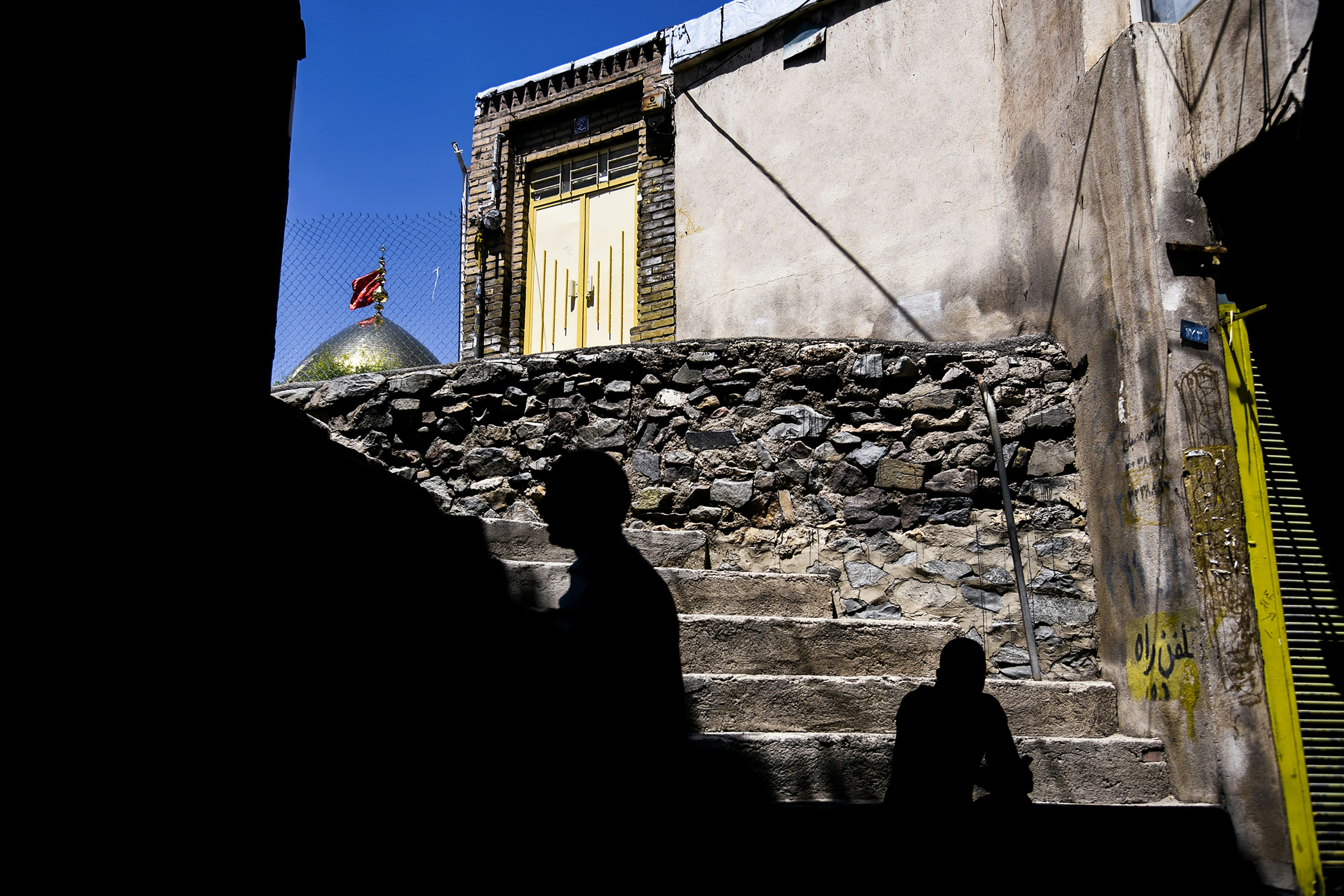 Someone passing through Ferdowsi Street, which is adjacent to Hoseiniyeh Azam Zanjan. - sep 2018