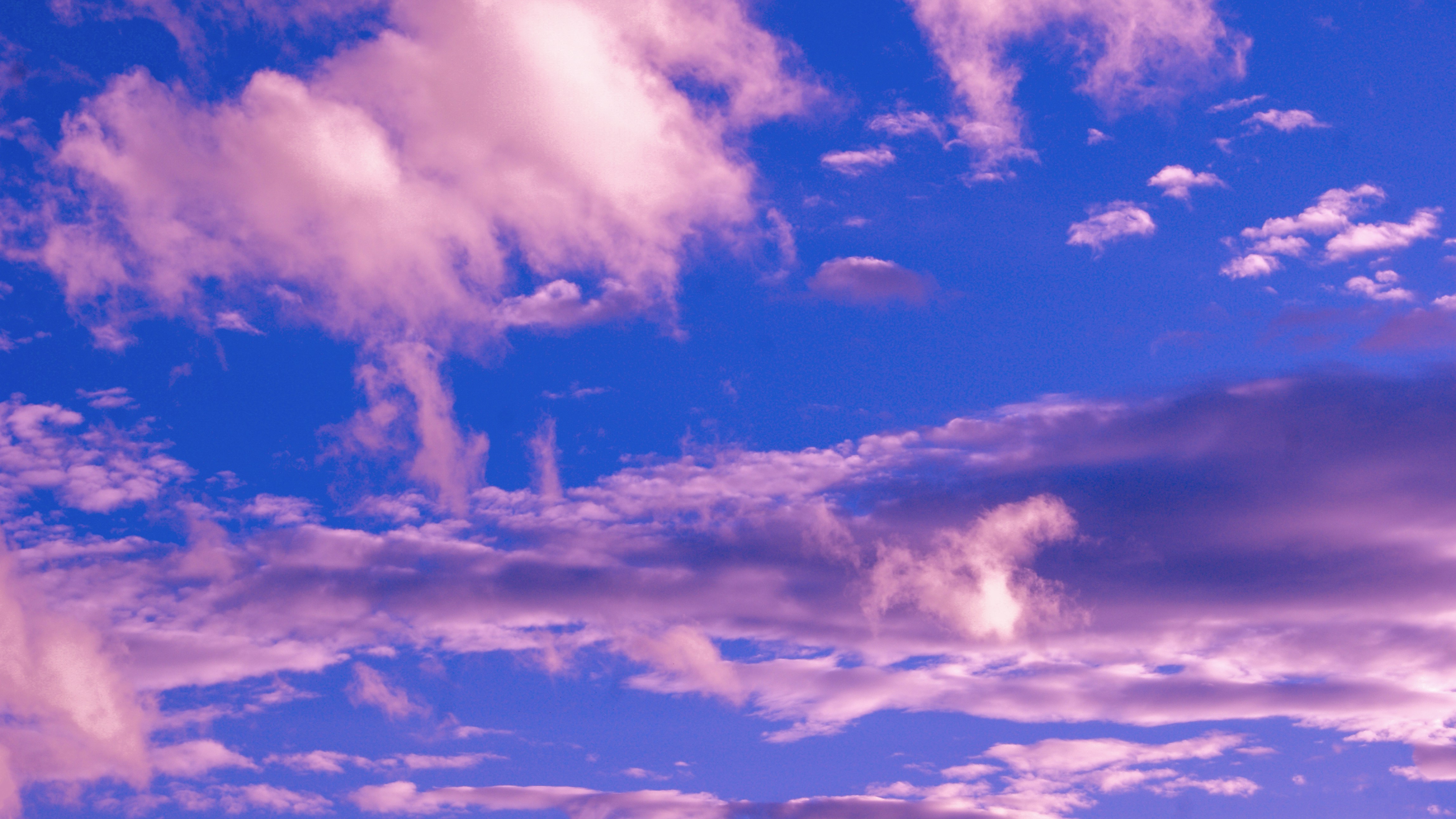 Vibrant clouds painted in hues of pink and purple, creating a serene twilight atmosphere.