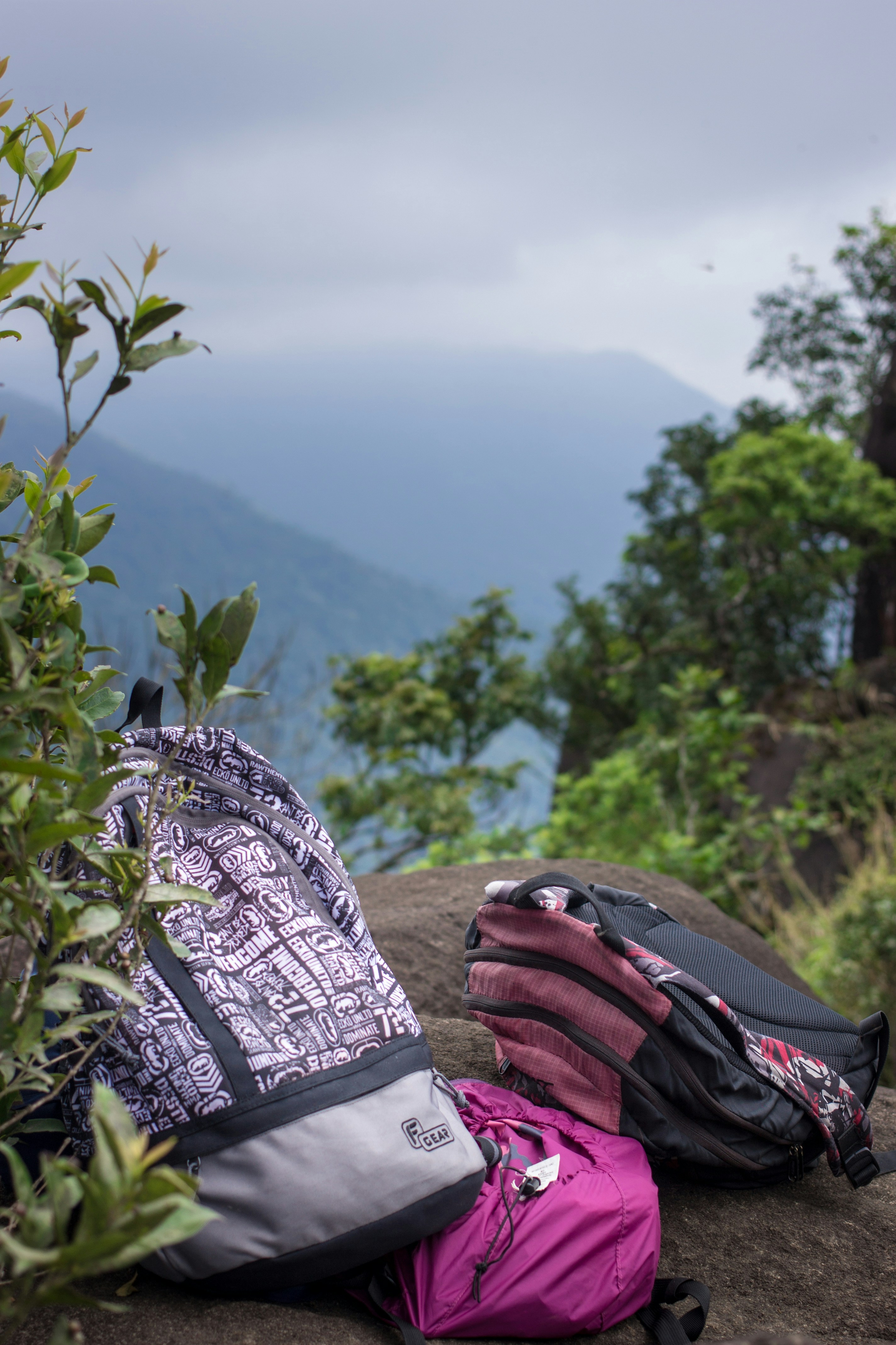 Three backpacks on gray rock under cloudy sky during daytime photo ...