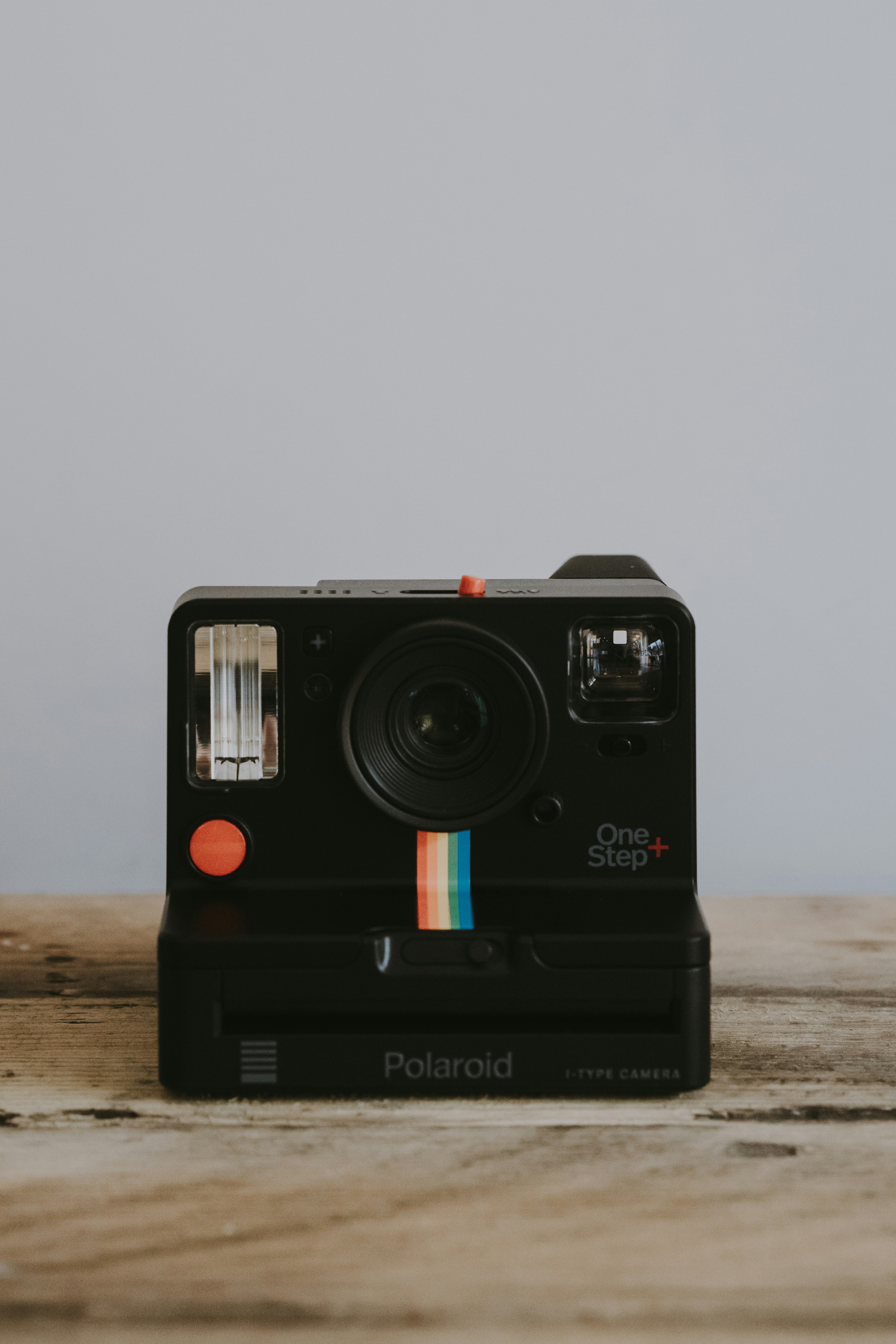 Black Polaroid One Step+ instant camera on brown surface photo – Free ...