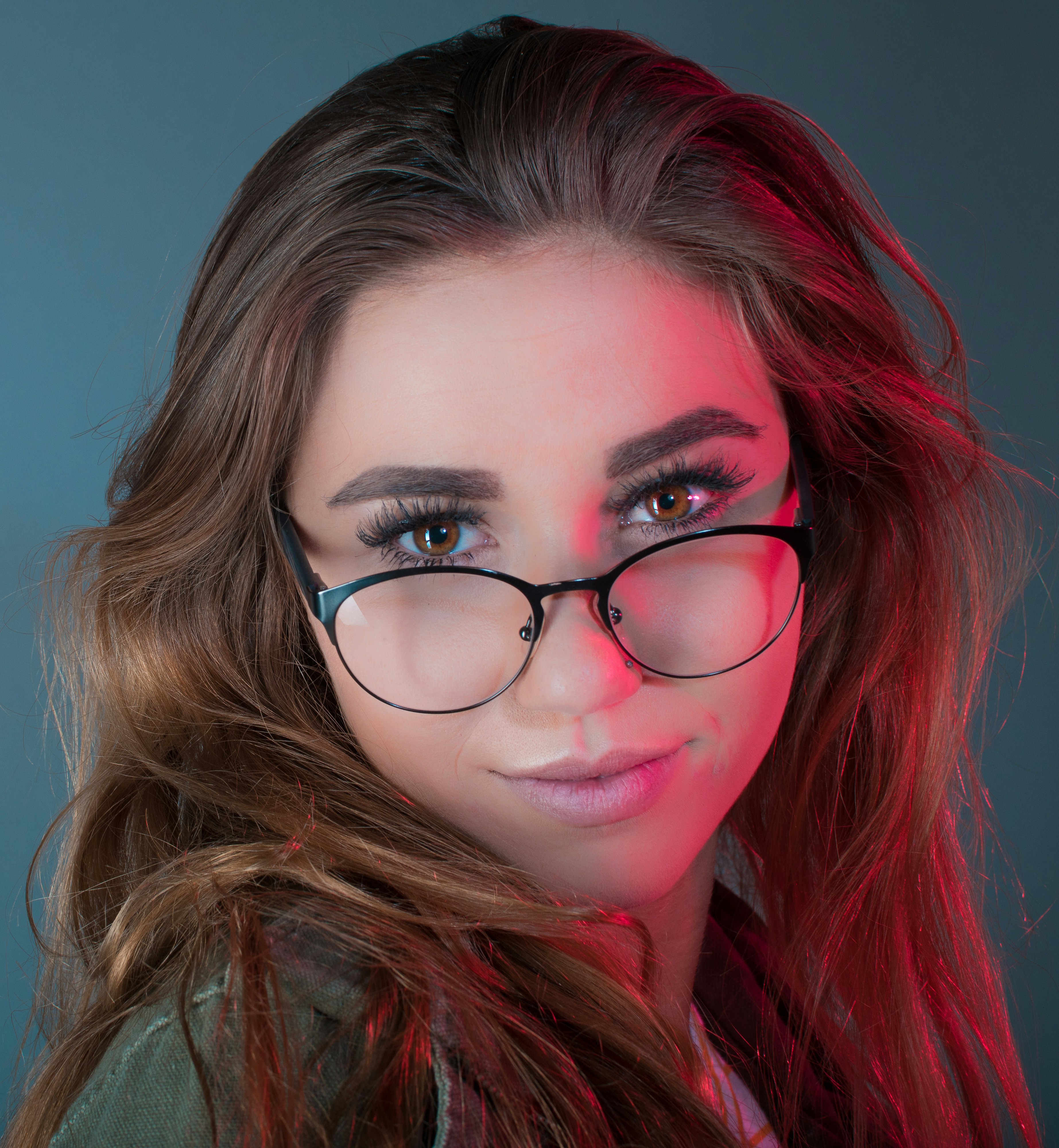 Studio Photography, playing with lights and really trying to capture that stare into your soul kinda look | smiling woman wearing eyeglasses