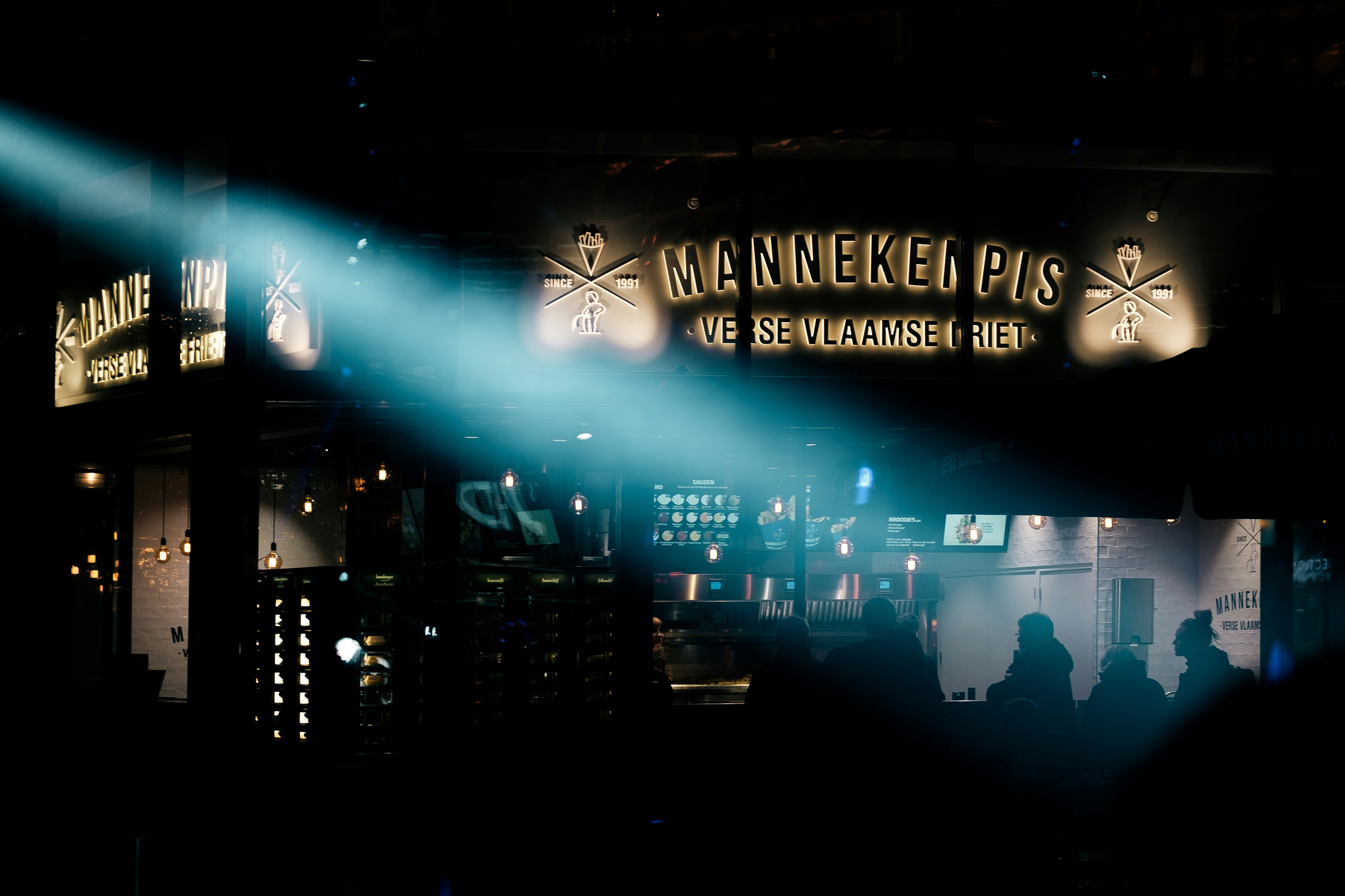 Mannekei Pis sign photo – Free Blue Image on Unsplash