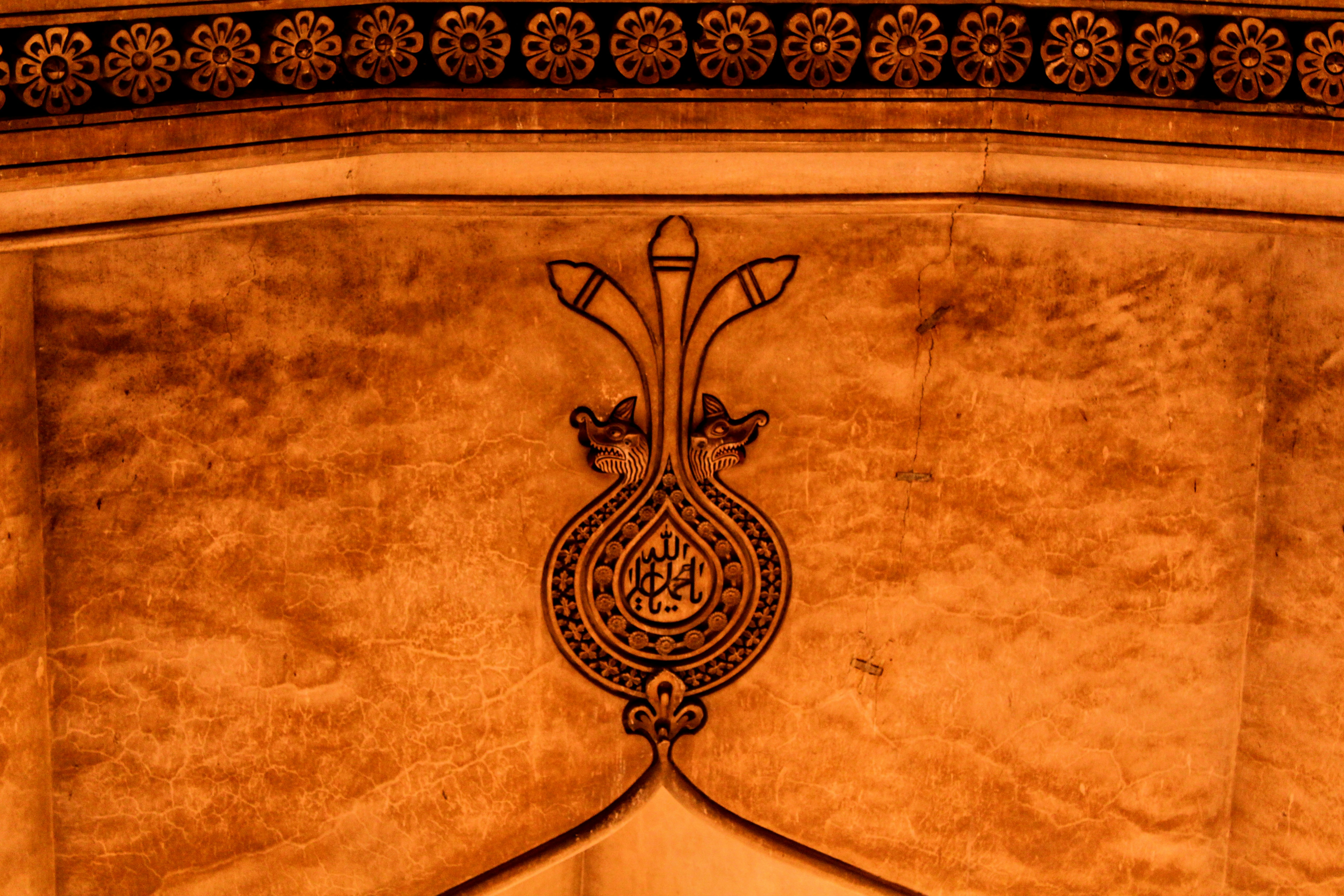 Ember-Warmed Arabesque Emblem in Stone Relief
