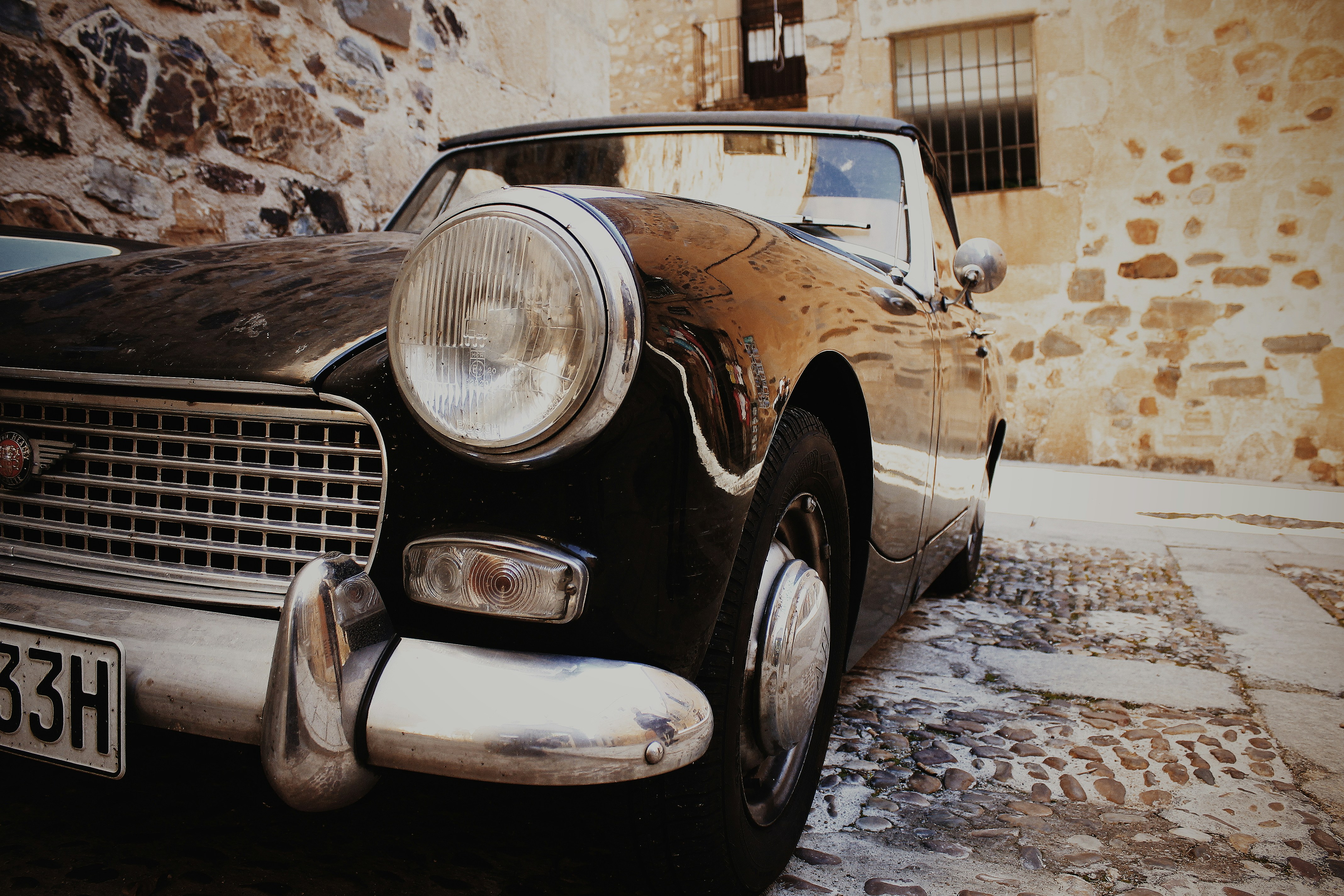 classic black vehicle parked beside building