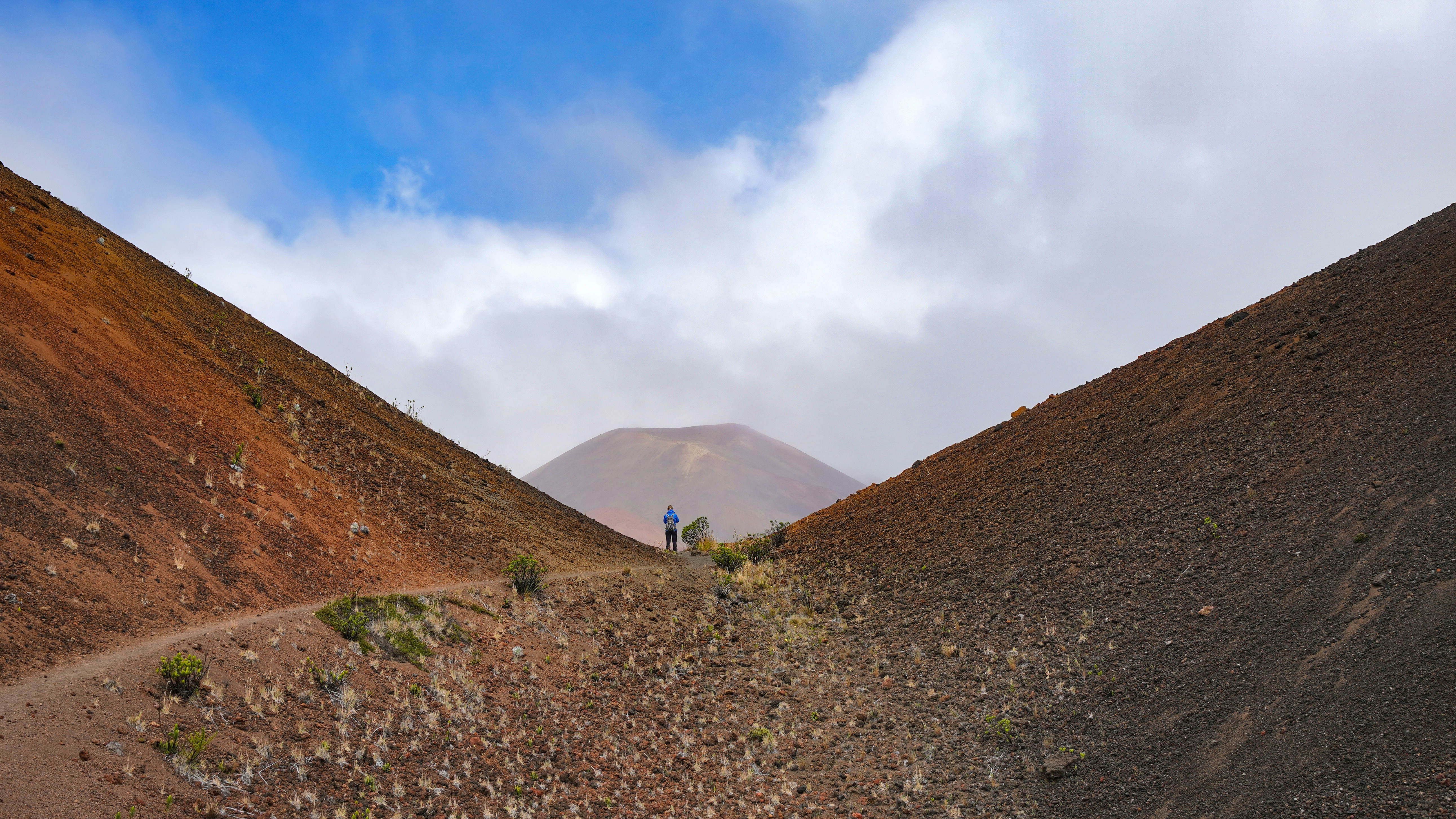 Hiking Haleakalā national park, Hawaii | person between brown mountains