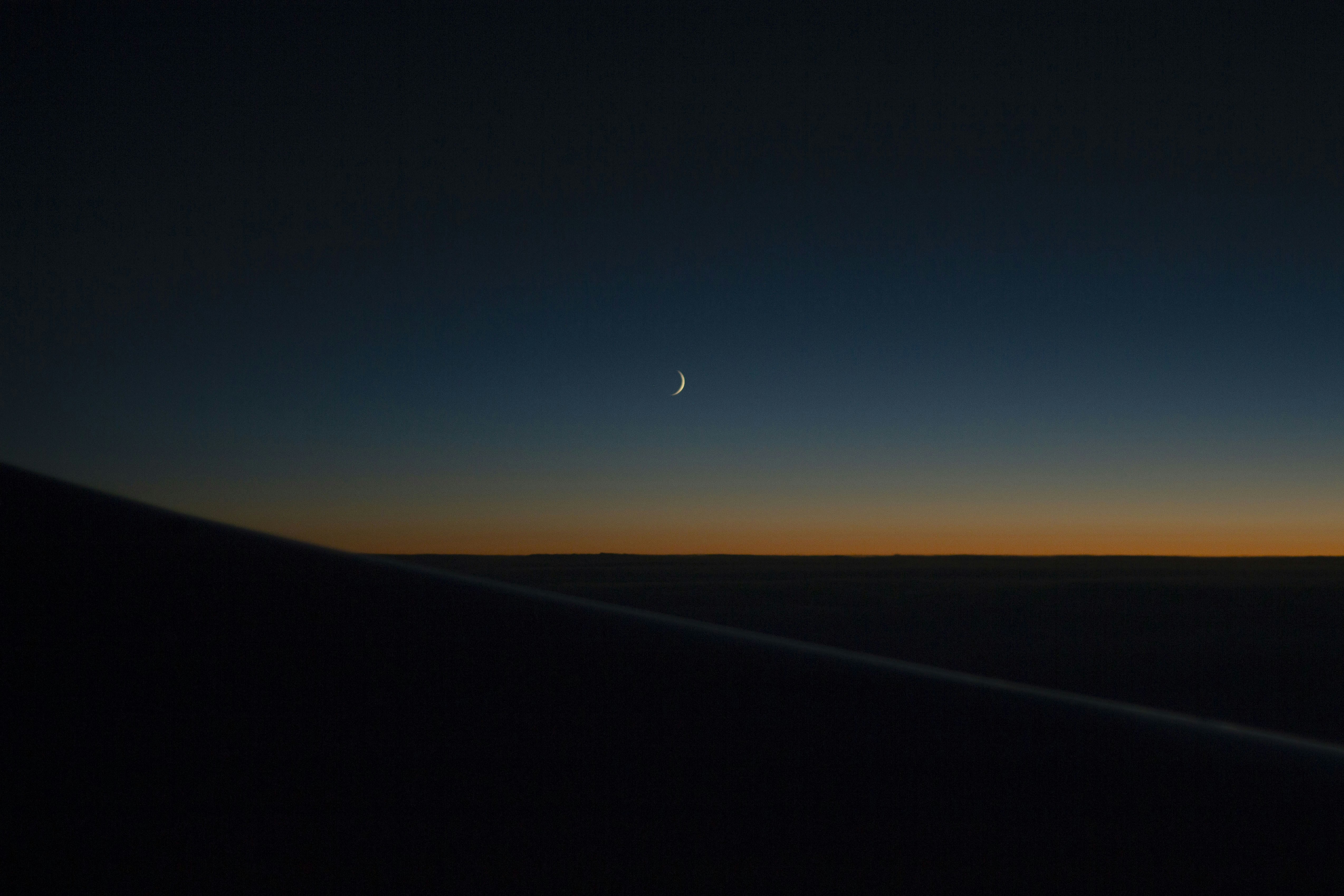 Crescent Moon Over the Dune Ridge at Twilight