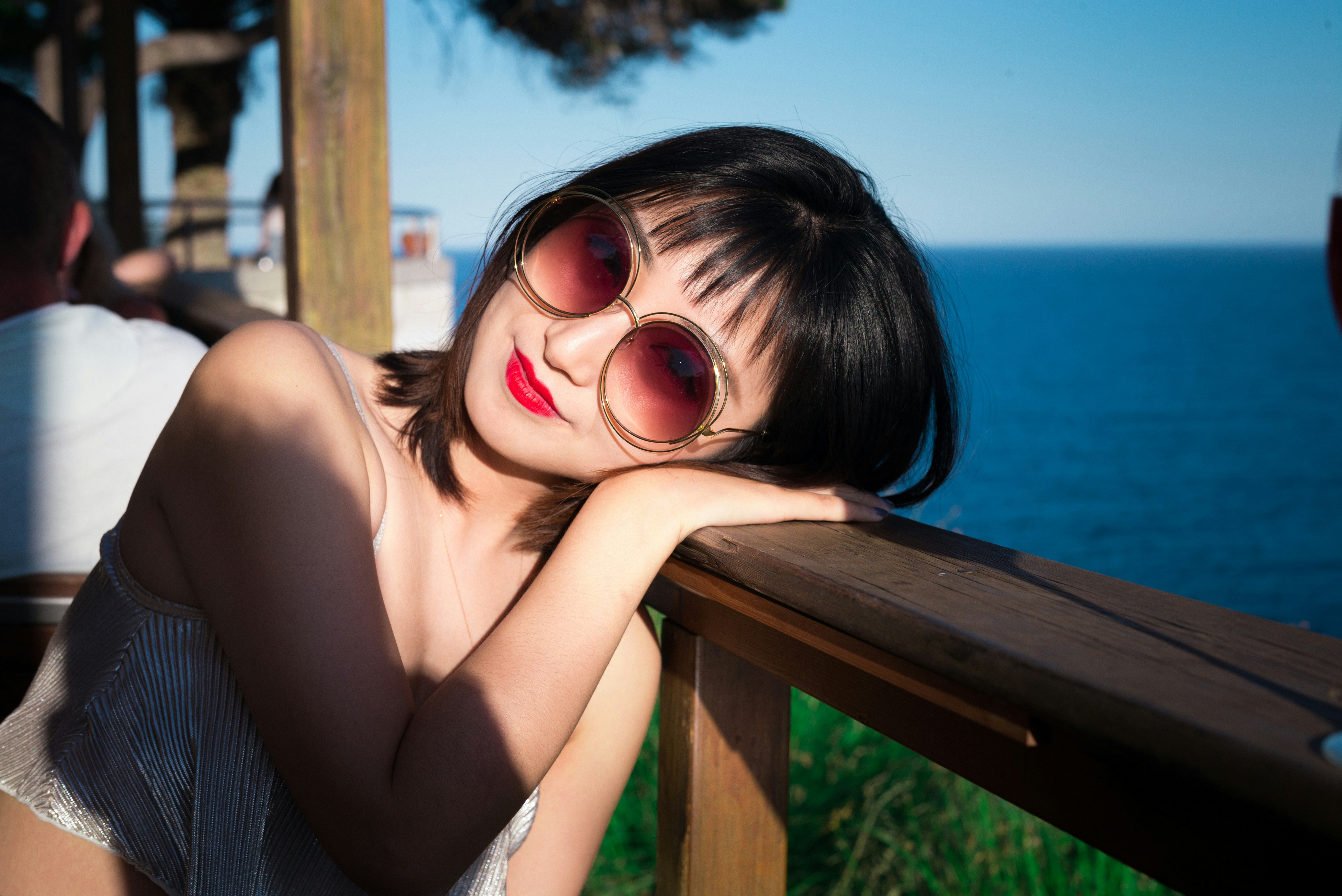 Sunlit Seduction: A Beachside Moment in Pink Sunglasses
