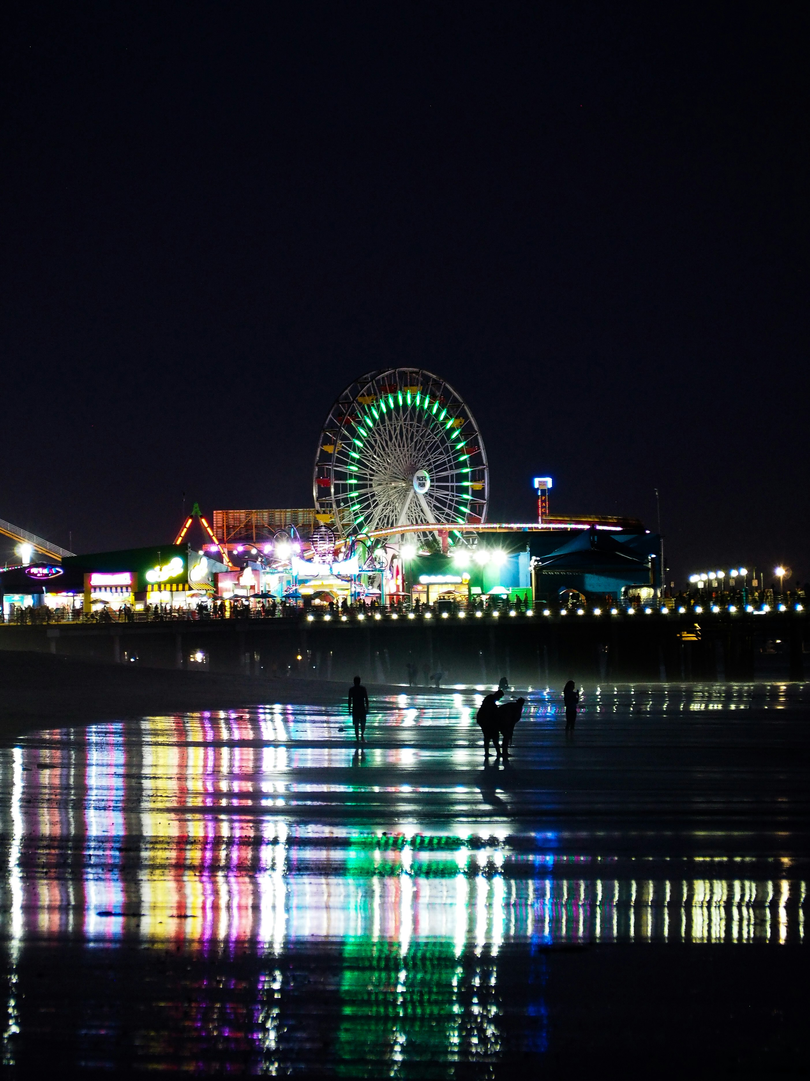 Neon Coastal Wheel: Night Ride by the Pier
