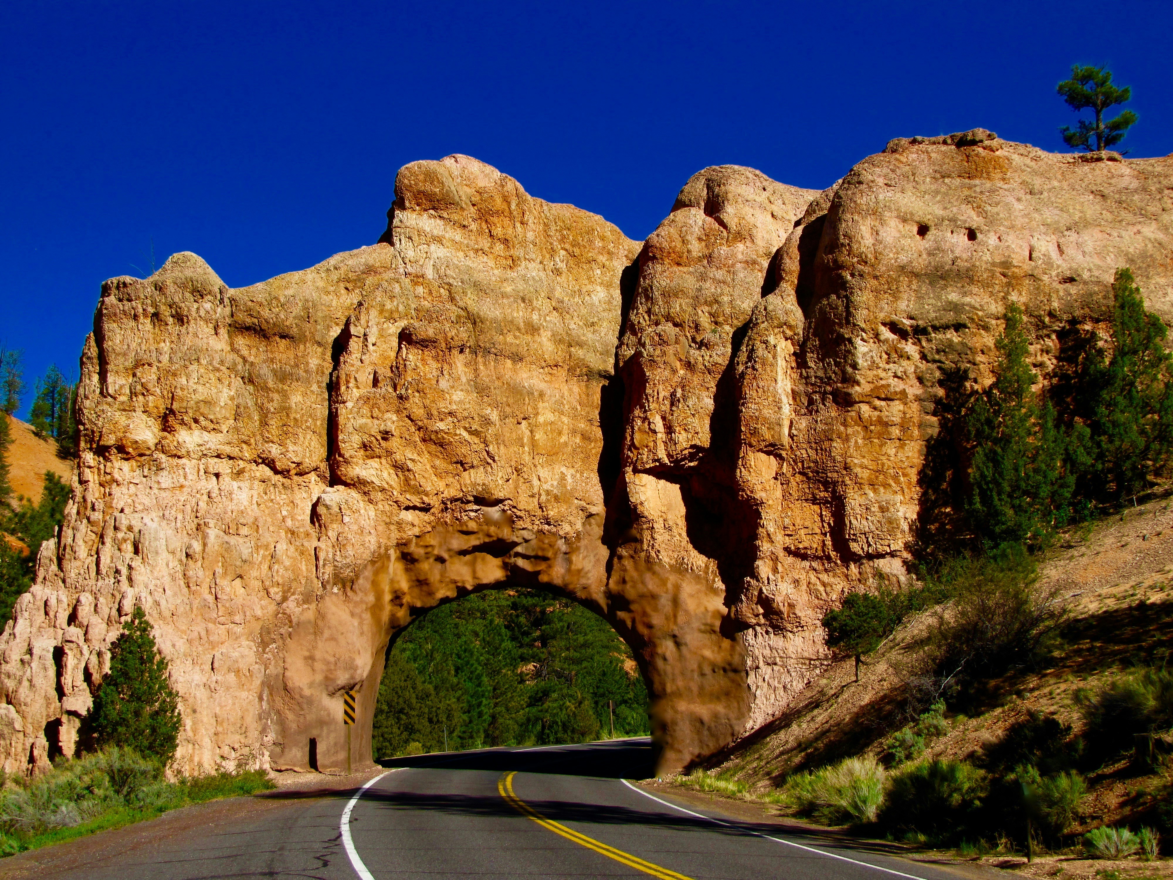 Gateway of Granite: The Desert Arch Framing a Winding Highway