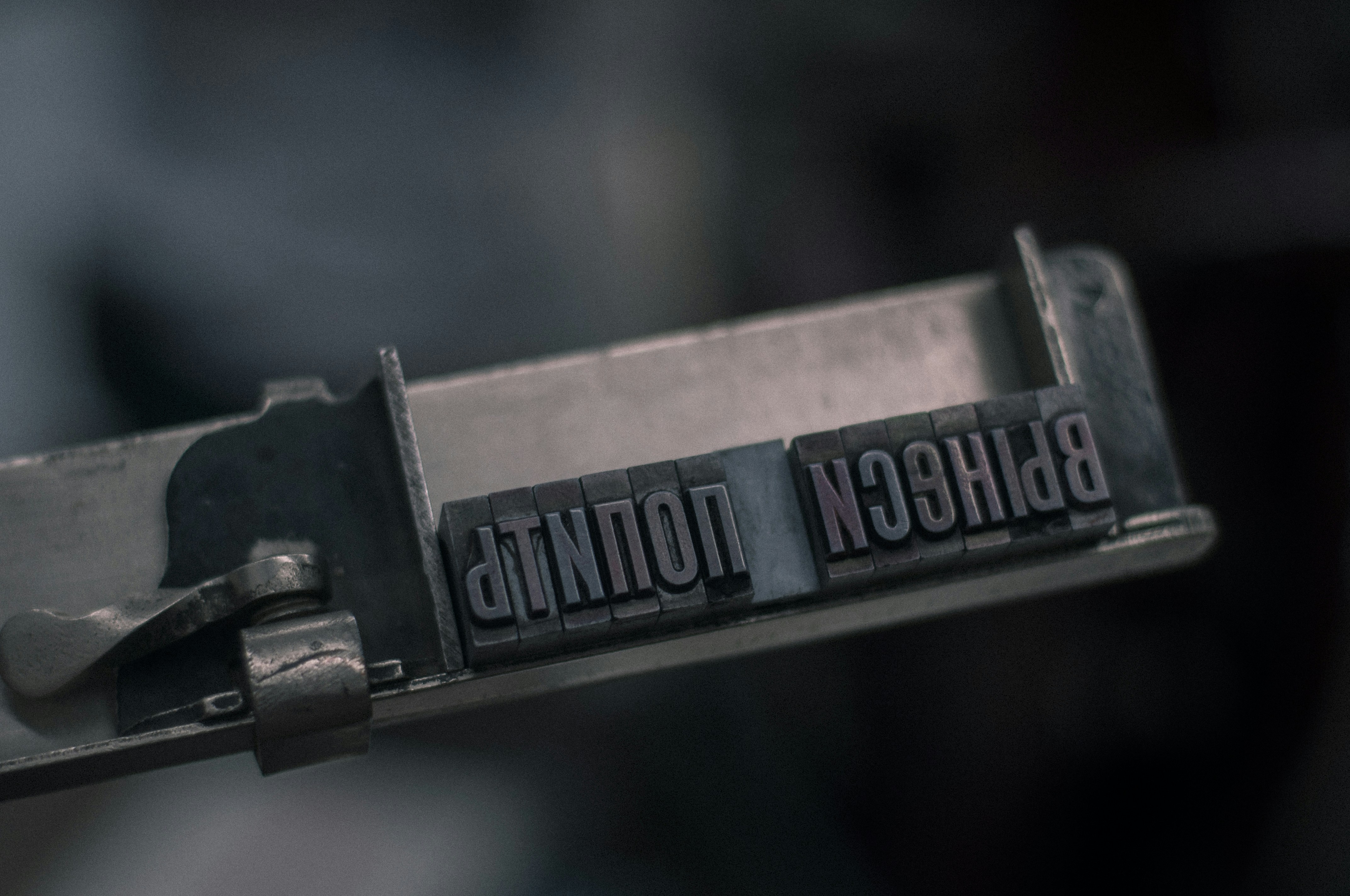 Close-up of vintage letterpress type blocks arranged in a tray, showcasing the craftsmanship of traditional printing methods.