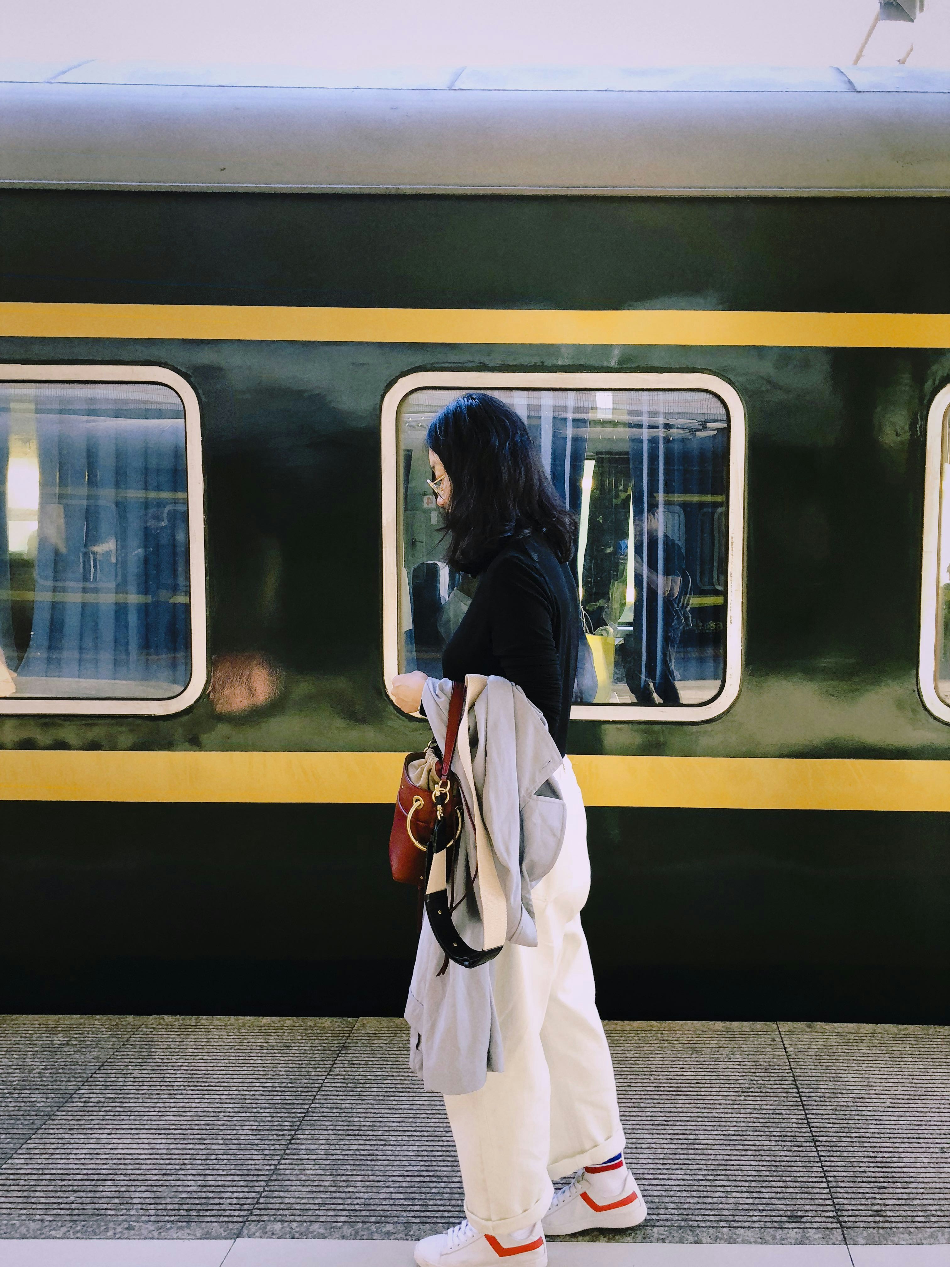 Woman standing holding red bag near train photo – Free 310003 Image on ...