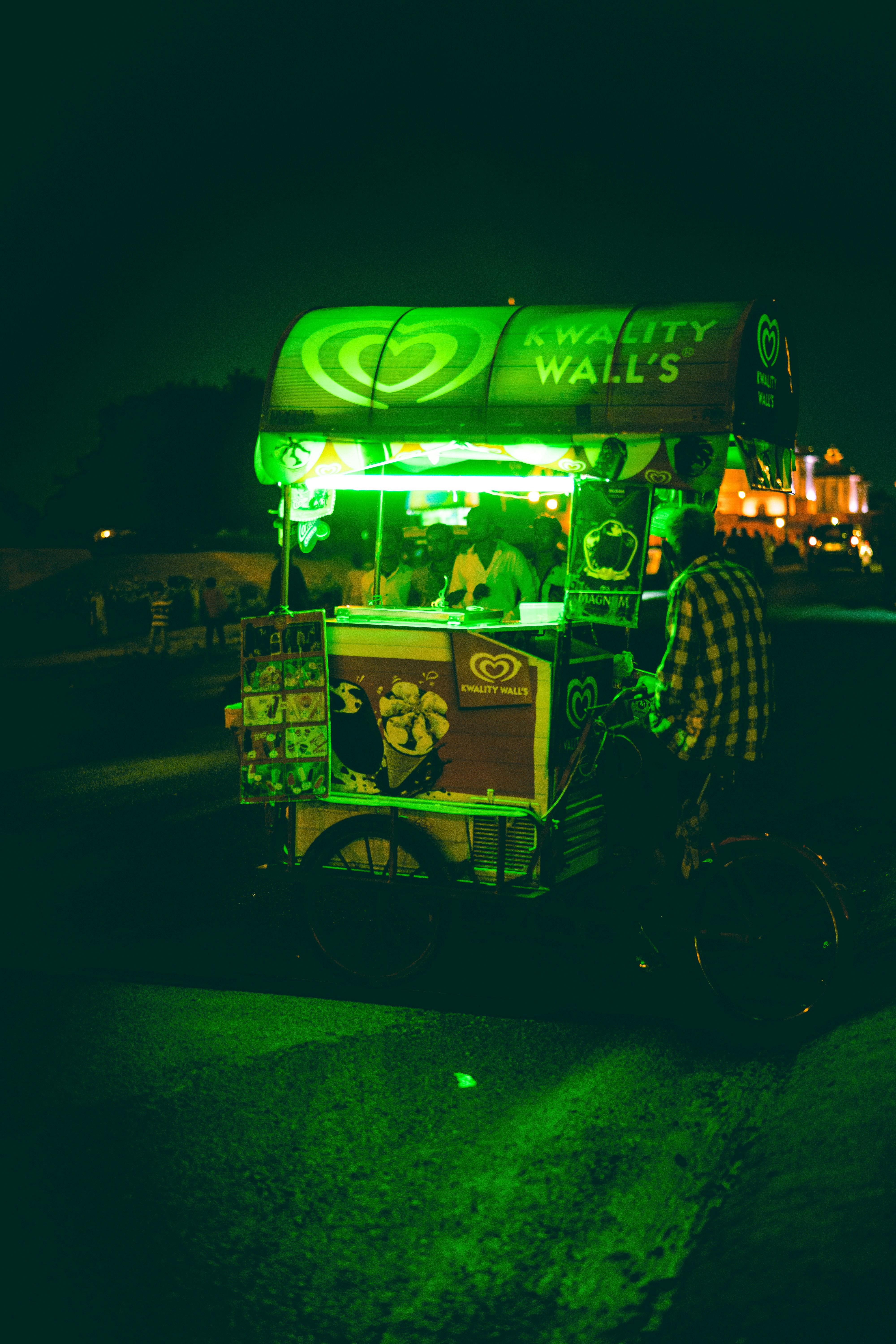Neon-Green Night Cart: Illuminated Street Snack Stand in a Quiet City Glow